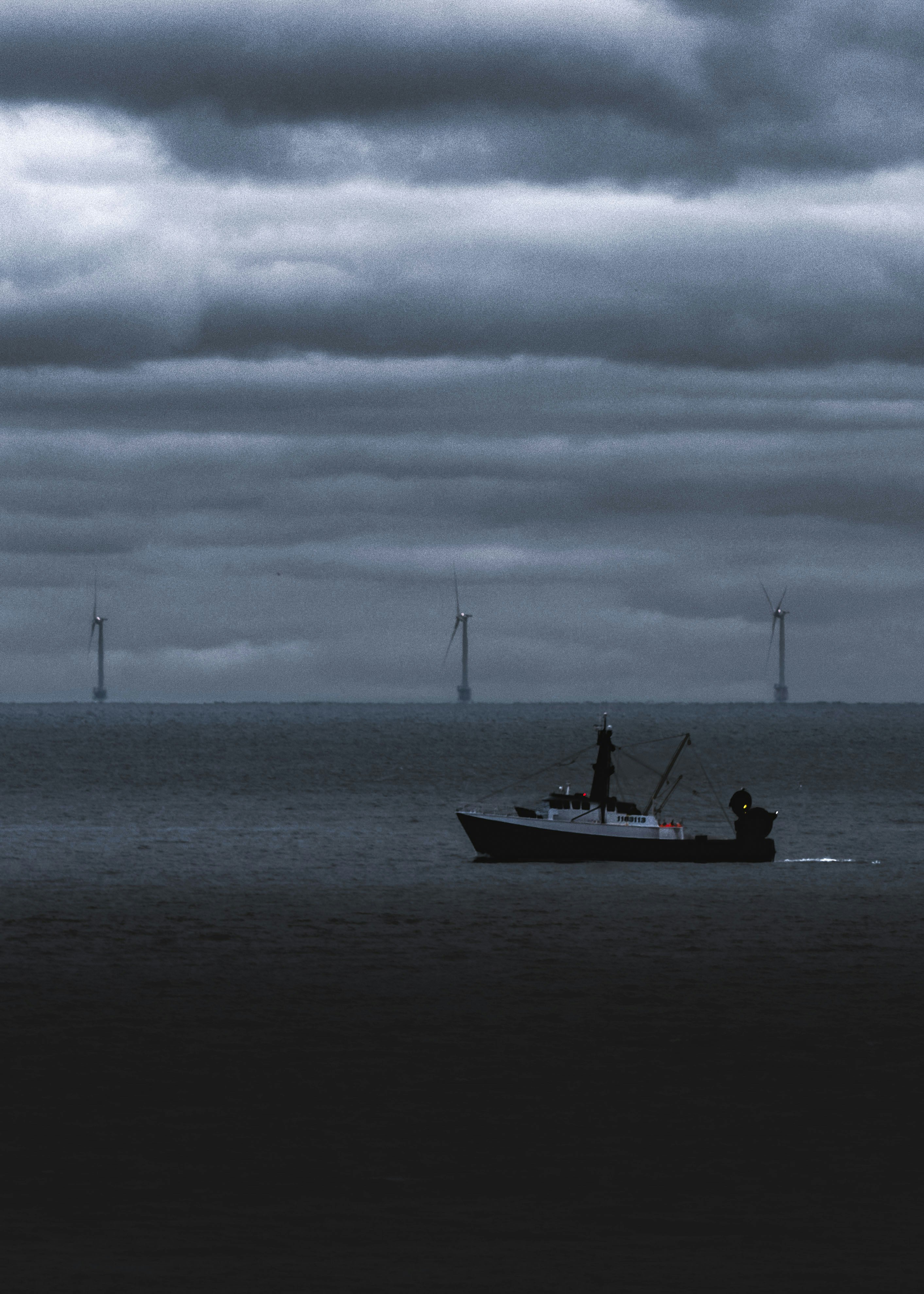 A small boat in the middle of a large body of water