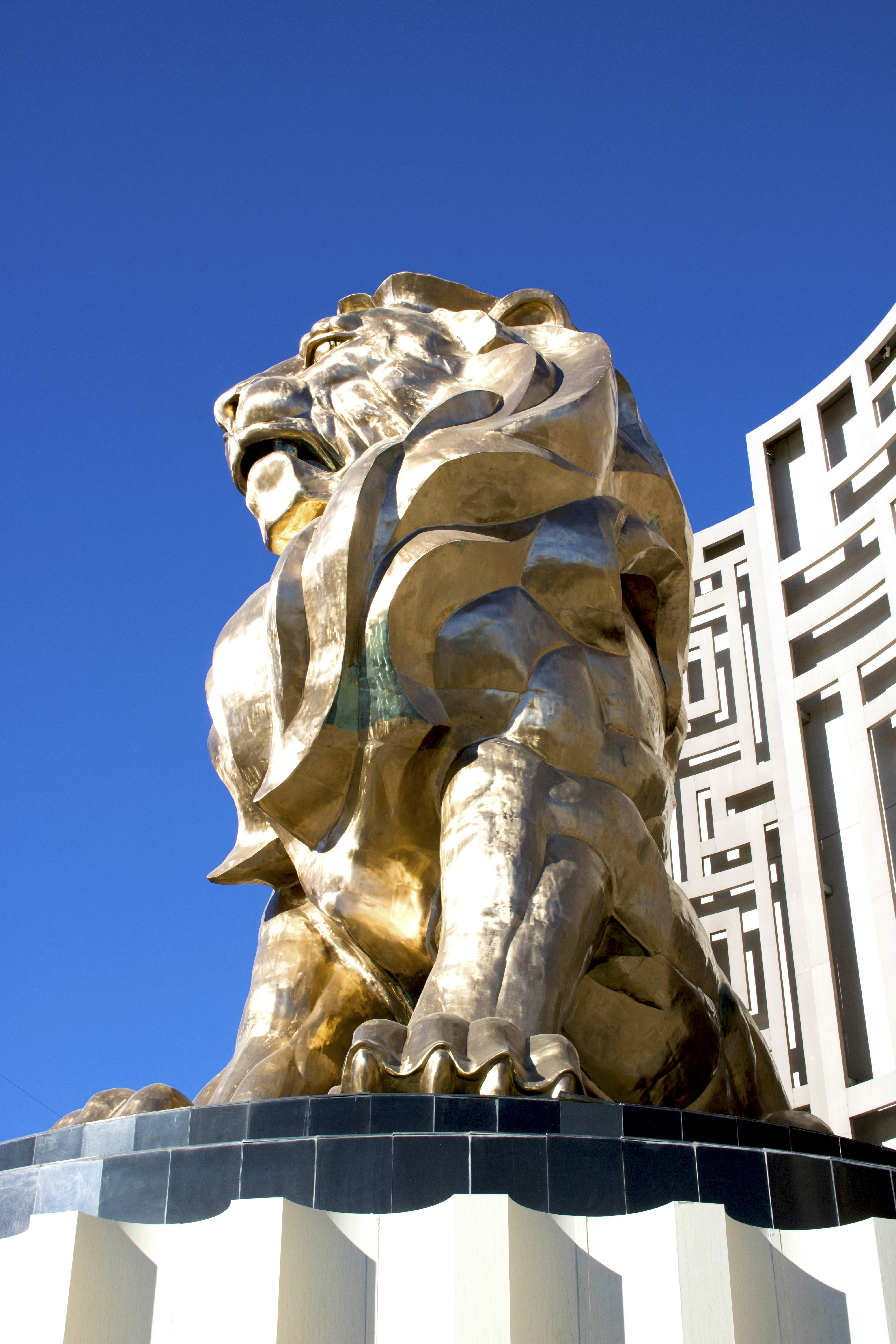Golden Guardian: The Lion Sculpture Reaching Toward the Blue Sky