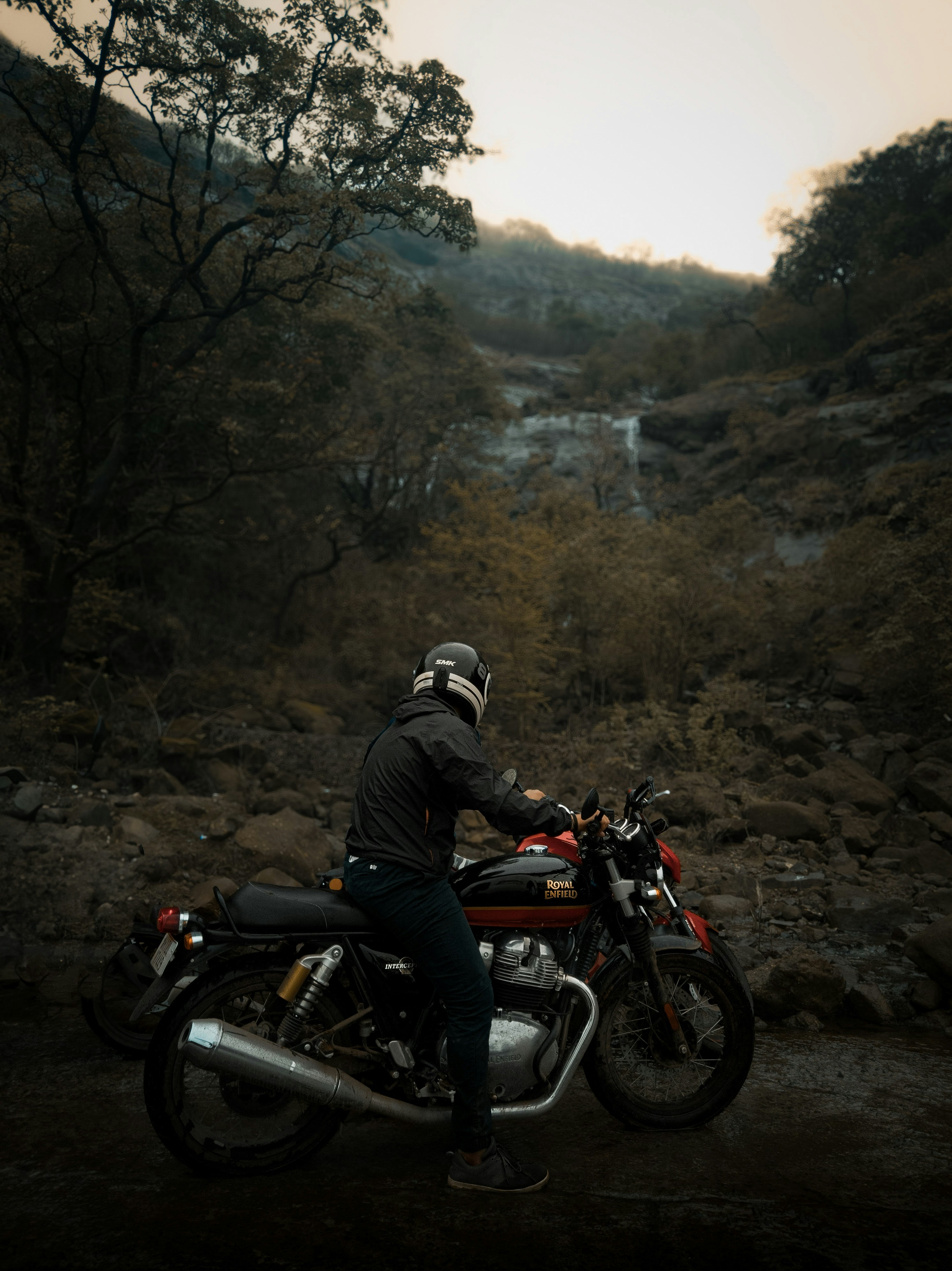 Dusk Ride in a Shadowed Gorge: A Rider on a Red Royal Enfield