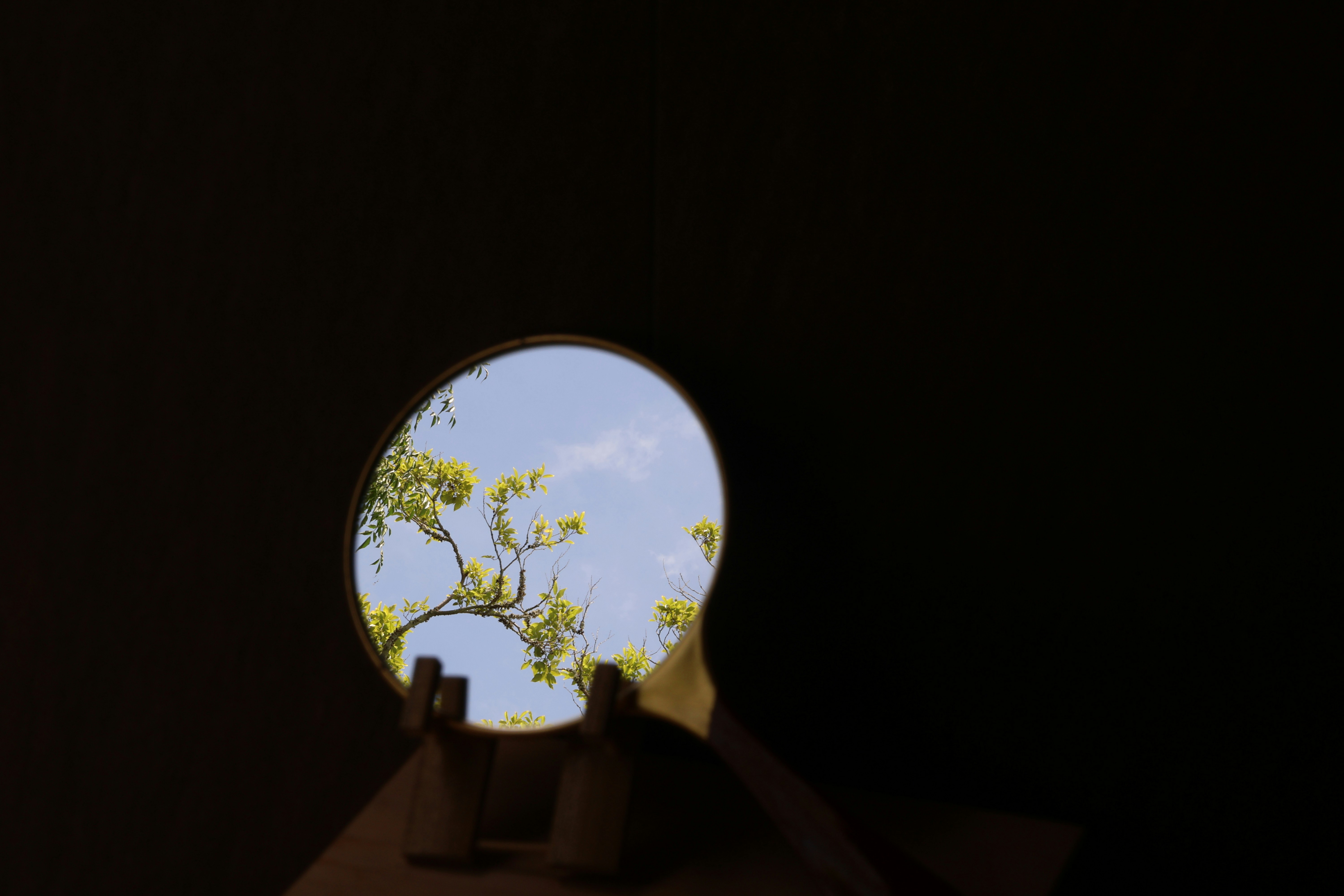 Blue Portal: A Circular Window Framed by Darkness