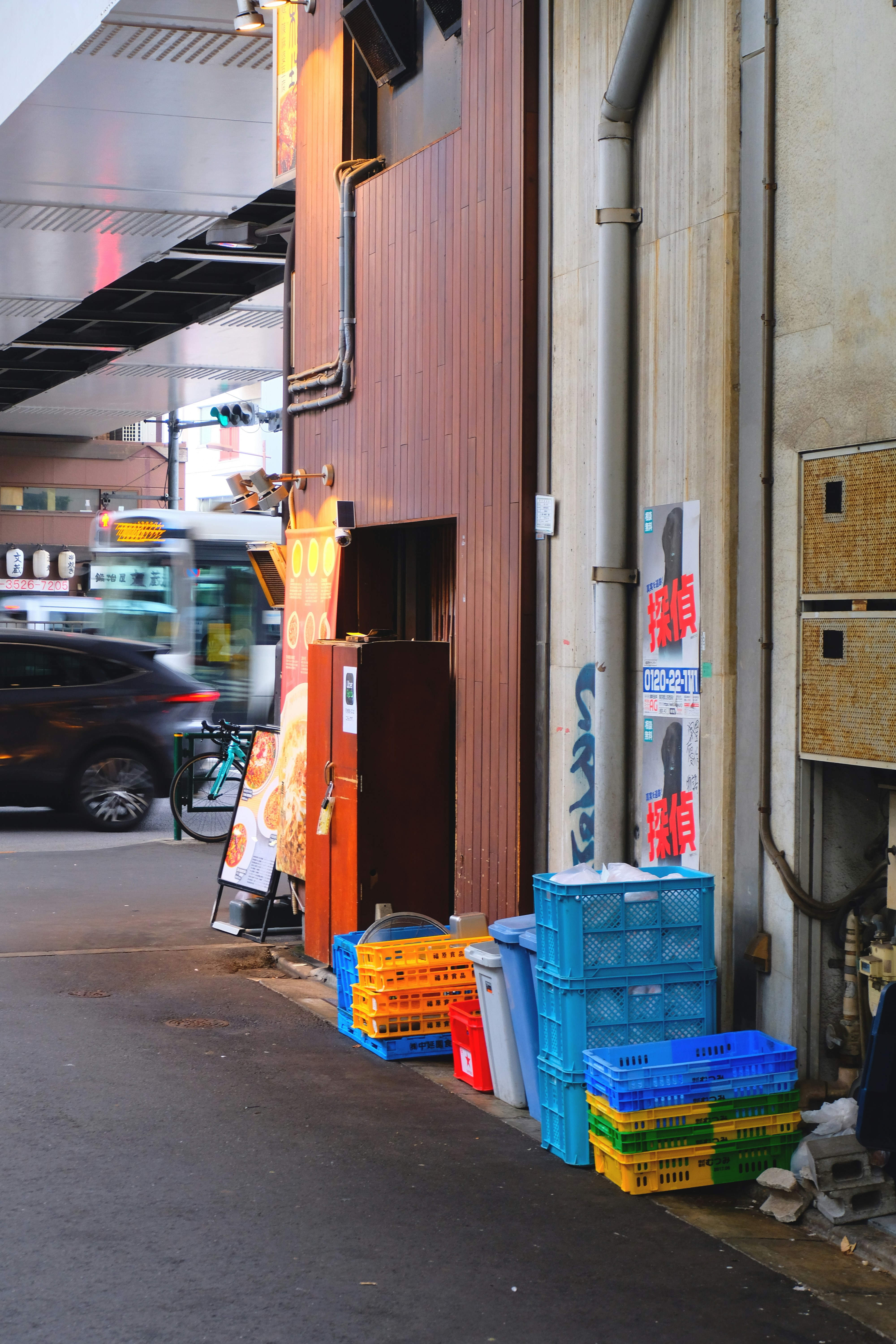 Urban Palette: Stacks of Blue Crates by a Narrow City Alley