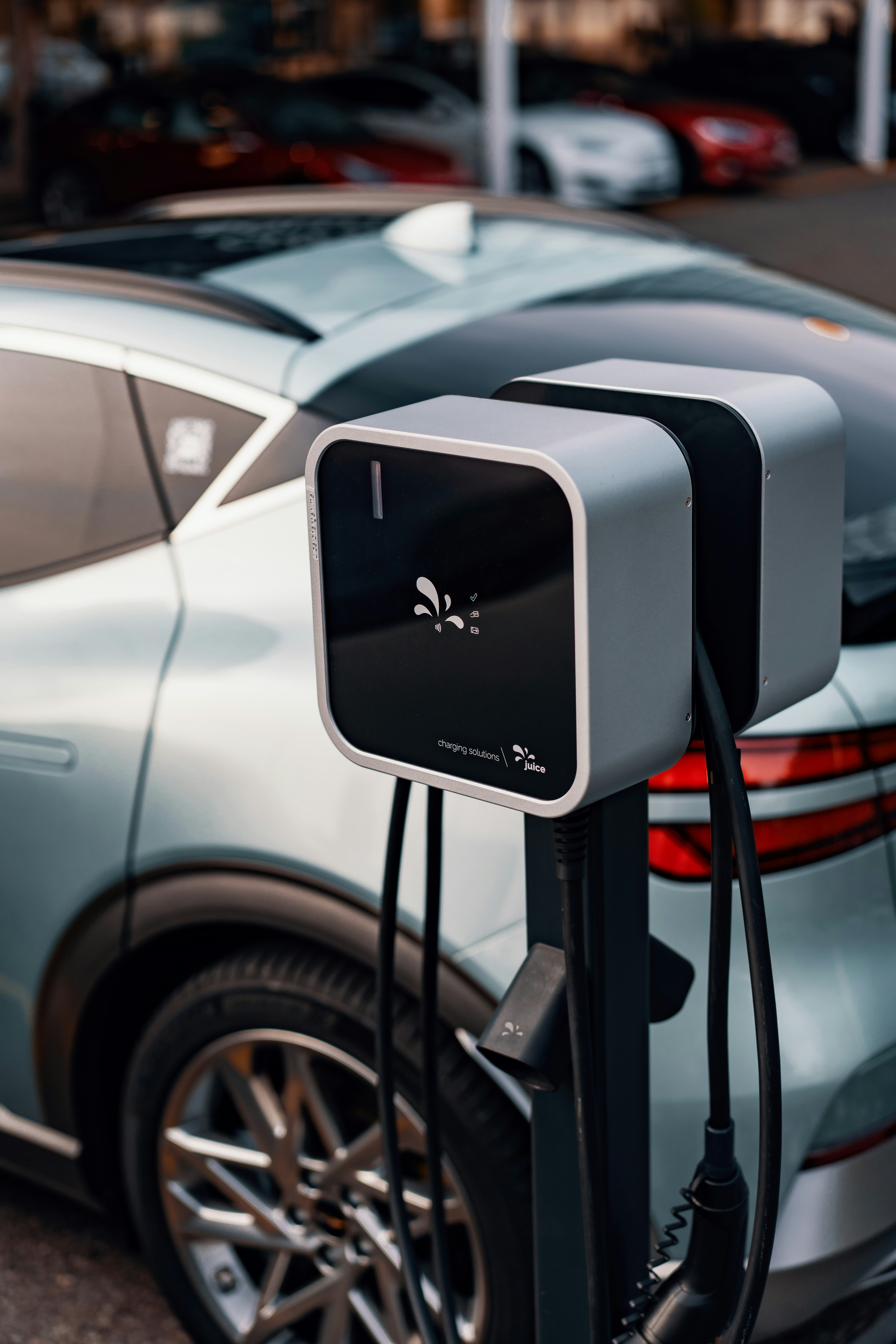 An electric car plugged in to a charging station photo – Free Cars Image on Unsplash