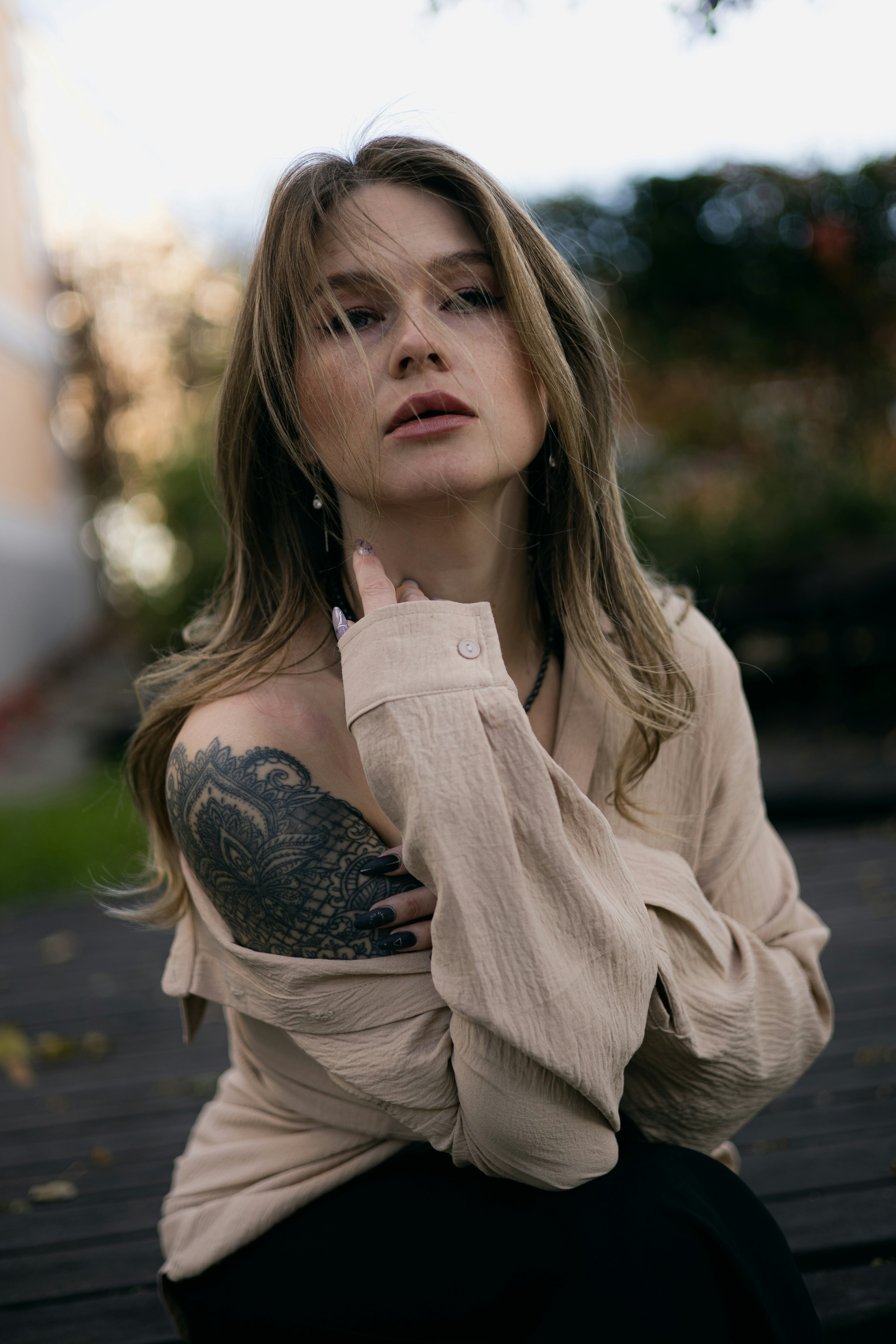 A woman with tattoos sitting on a bench photo – Free Face Image on Unsplash