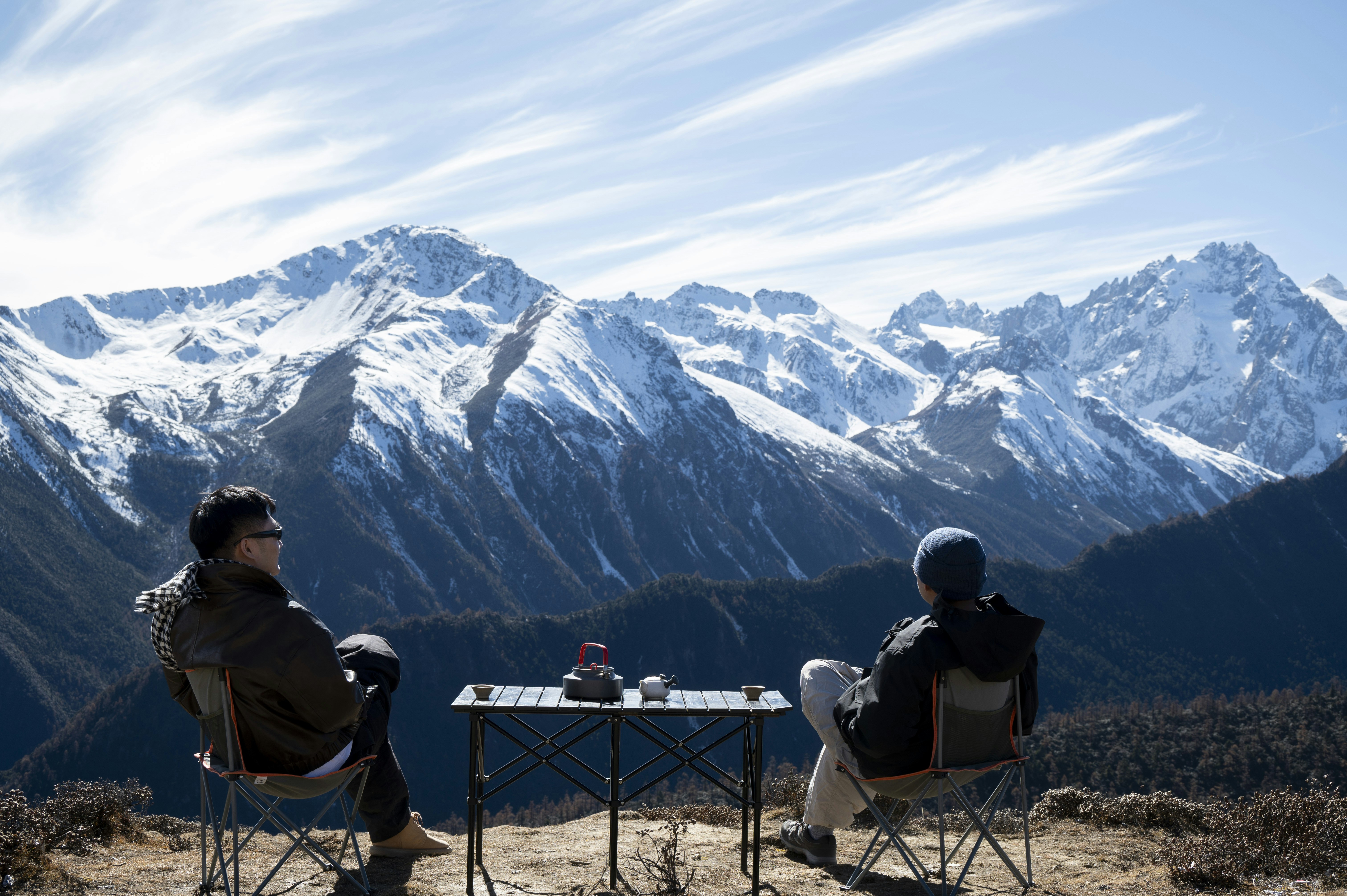 A Quiet Summit Break: Two hikers in a alpine overlook