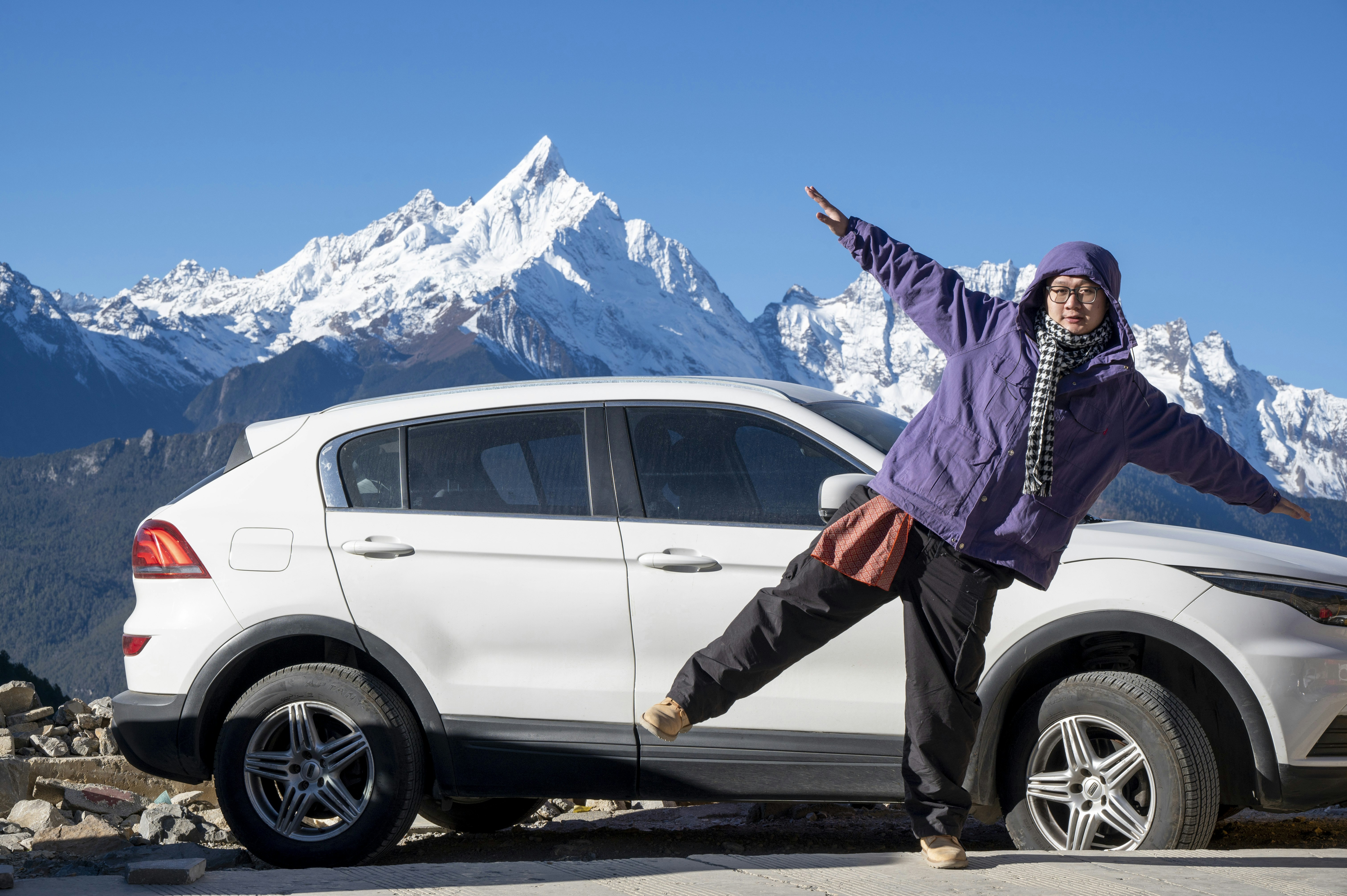 Graceful Balance at the Edge of the Avalanche: A Hiker in Sync with the Snowy Peaks