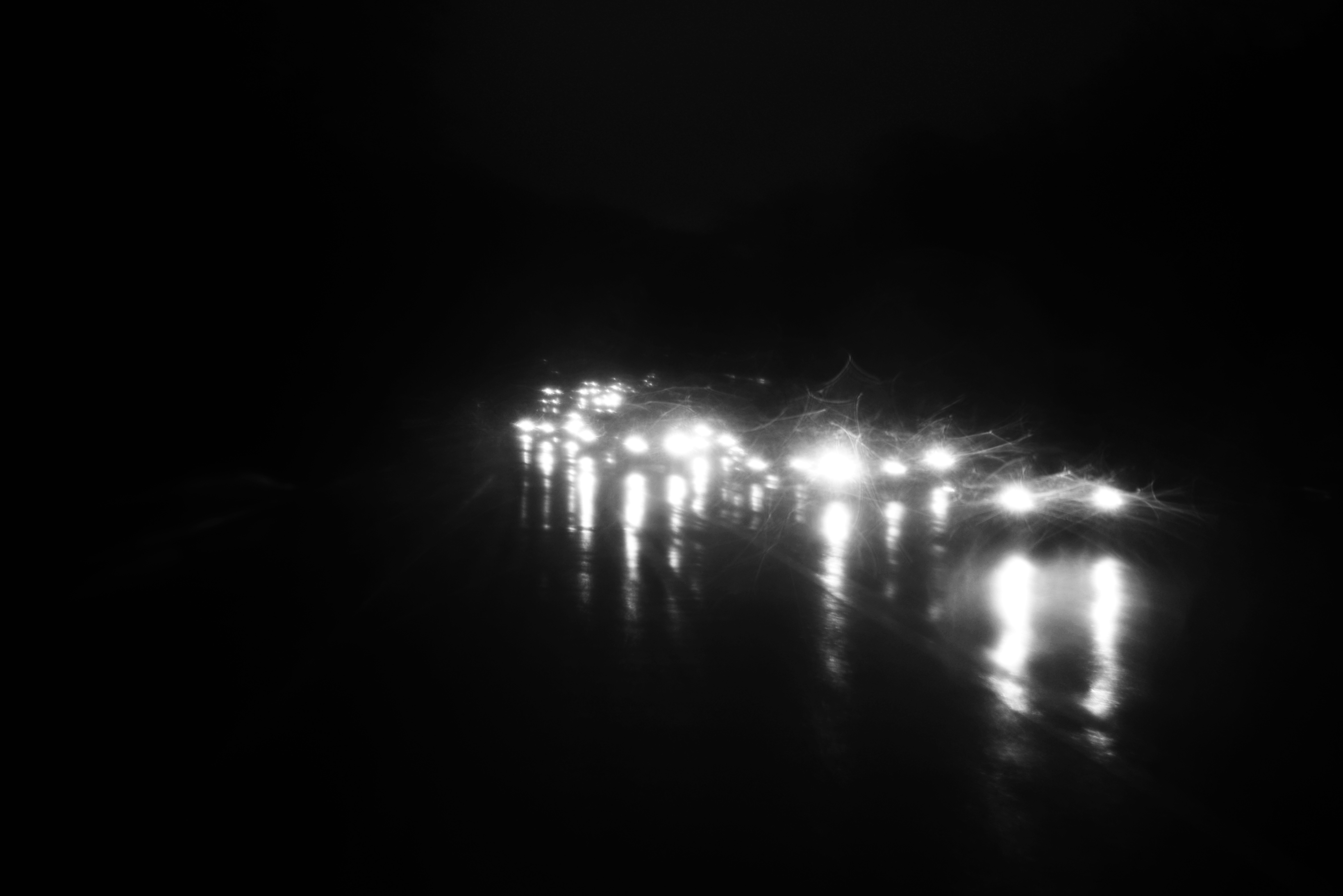 Row of Night Lights Rippling Across Velvet Water