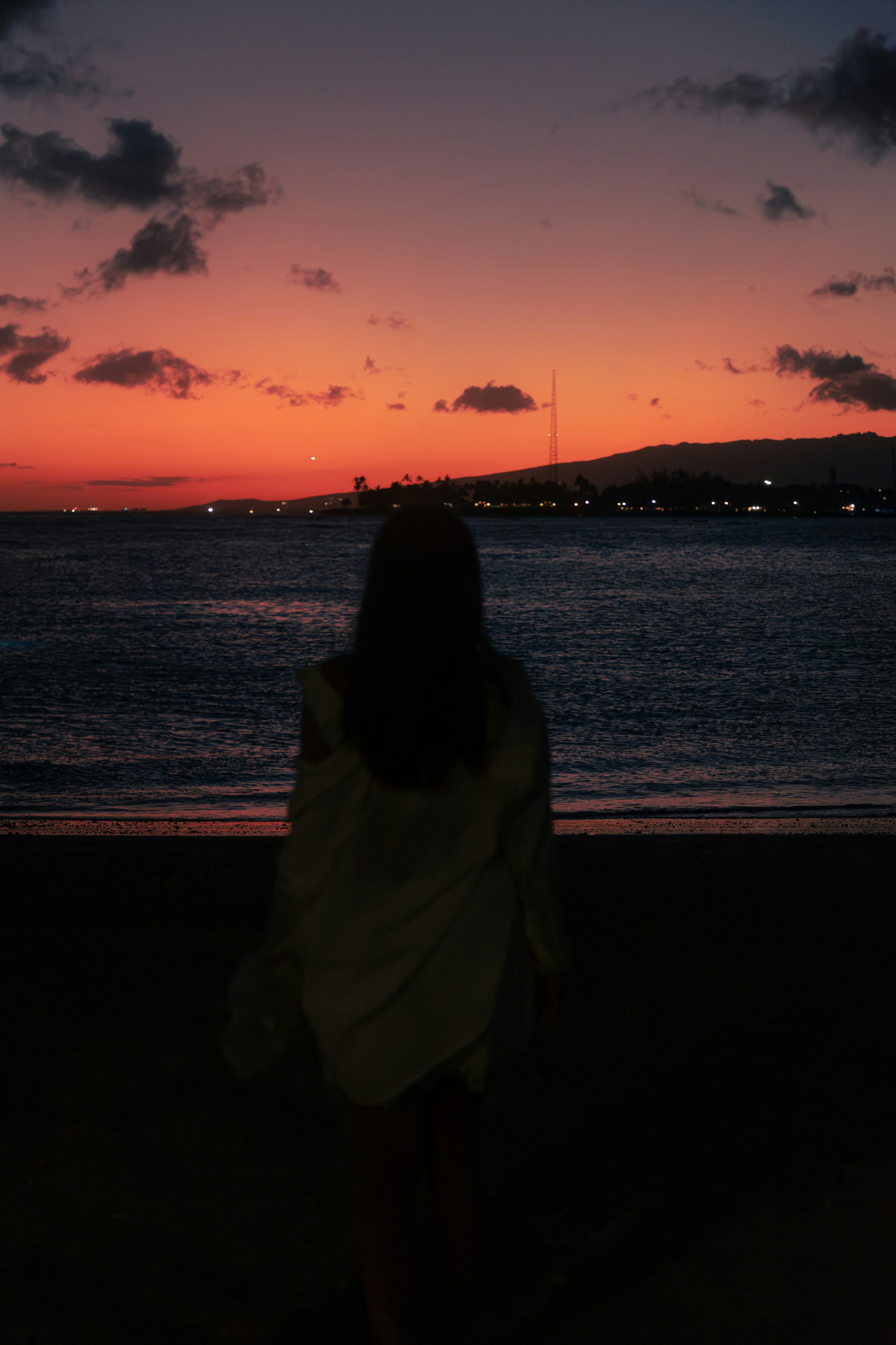 A woman standing on a beach at sunset photo – Free Beach Image on Unsplash