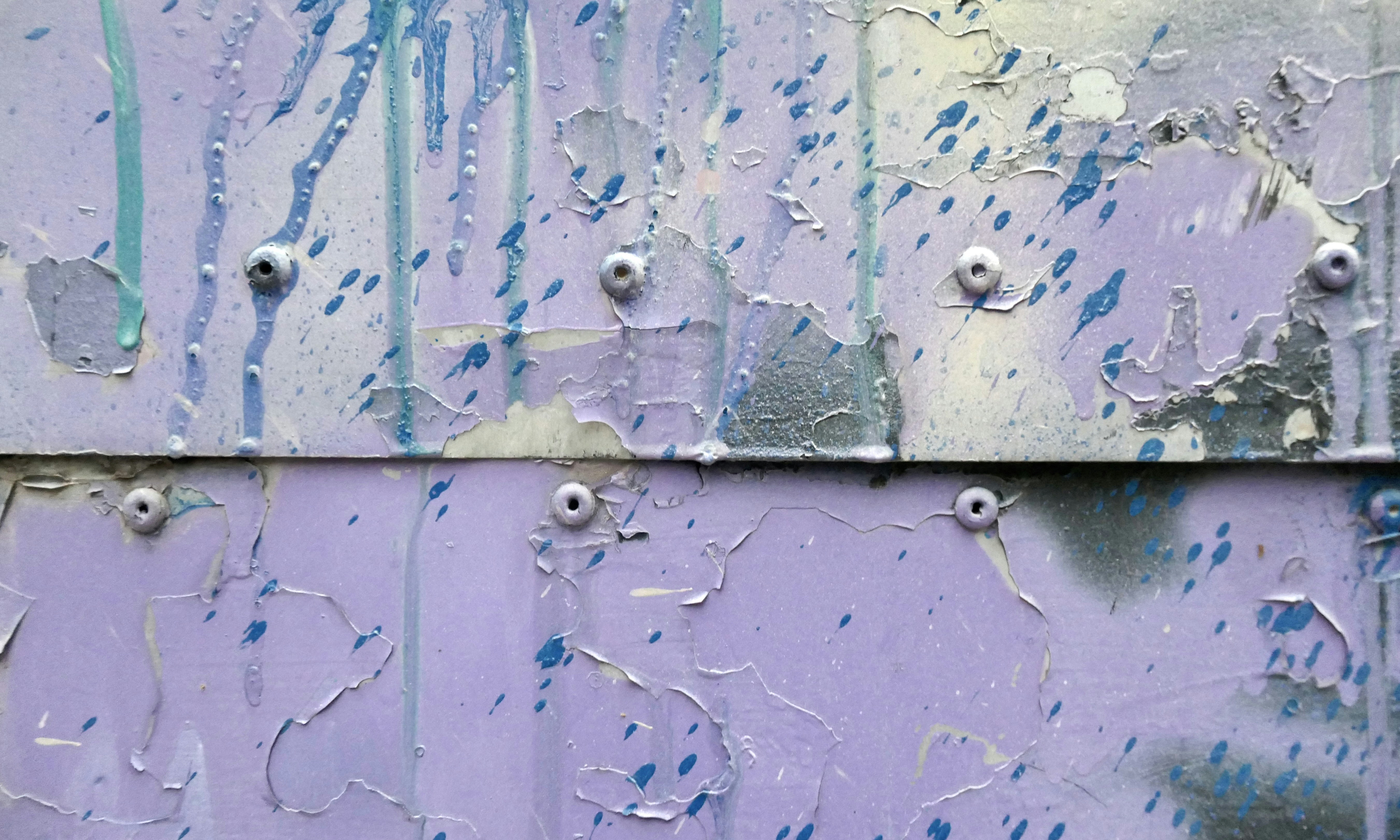 Seamed Violet: Peeling Paint and Screws on Weathered Purple Panels