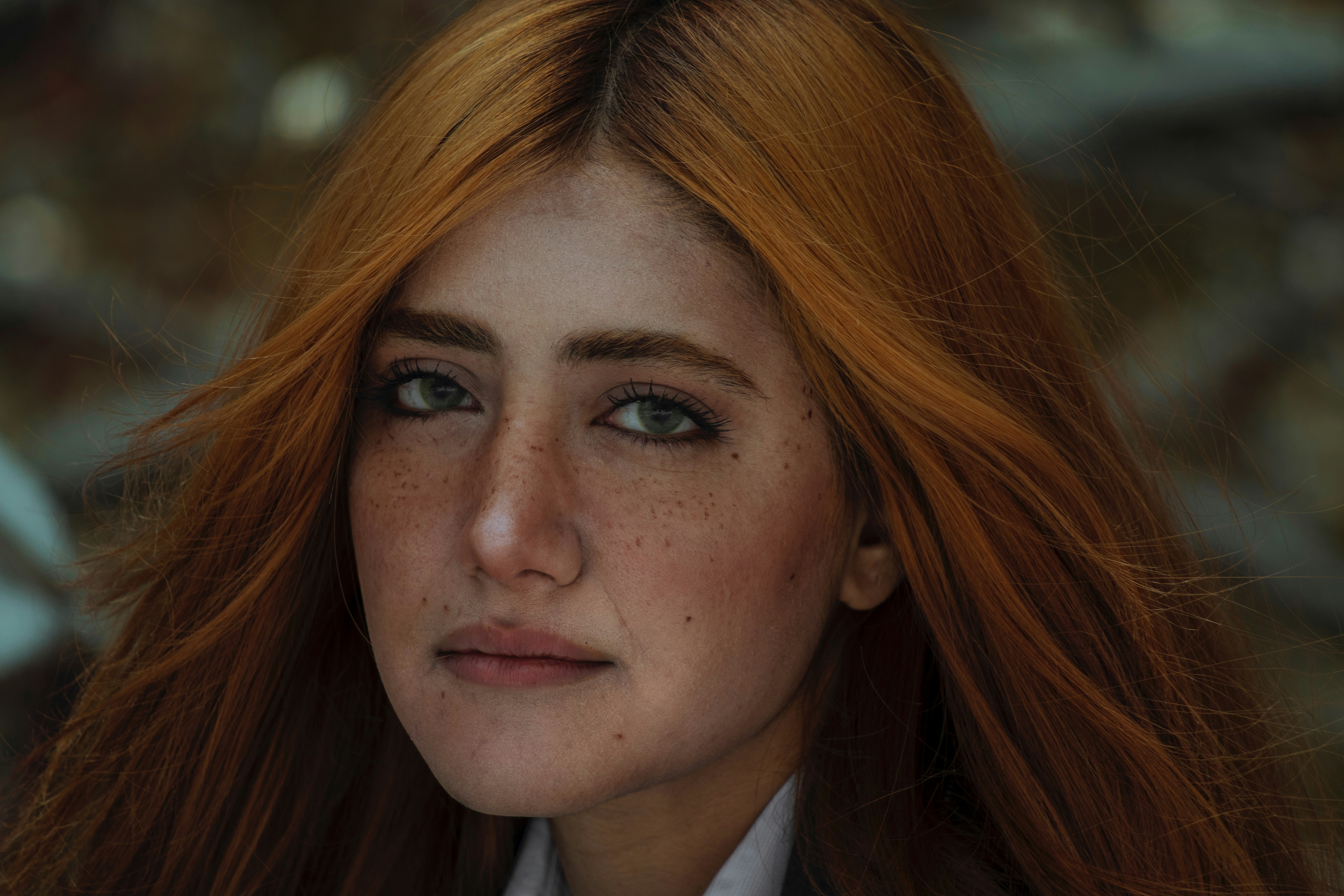 A woman with long red hair wearing a white shirt photo – Free Iran ...