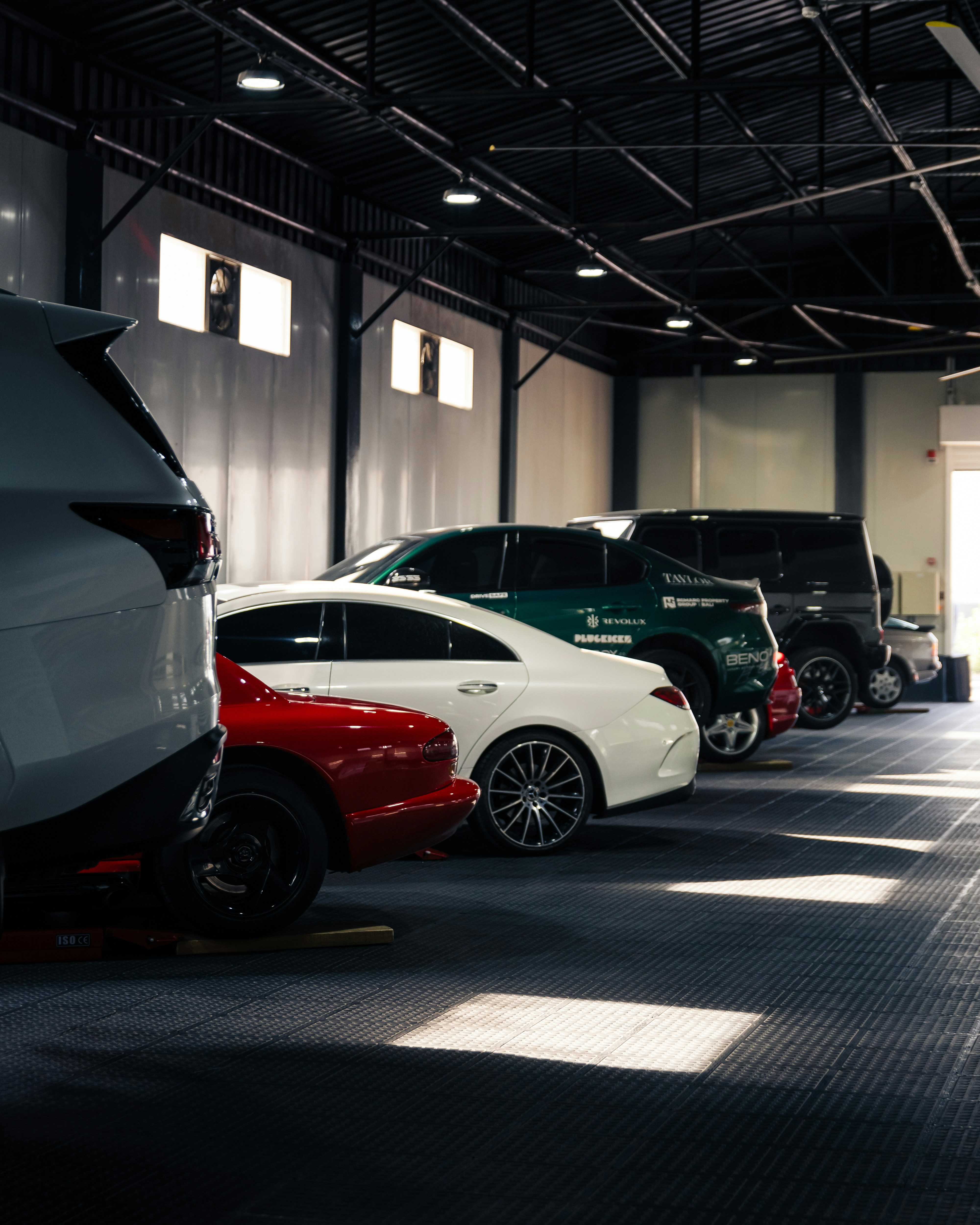 Muted Parallel: A Quiet Row of Cars in an Industrial Showroom