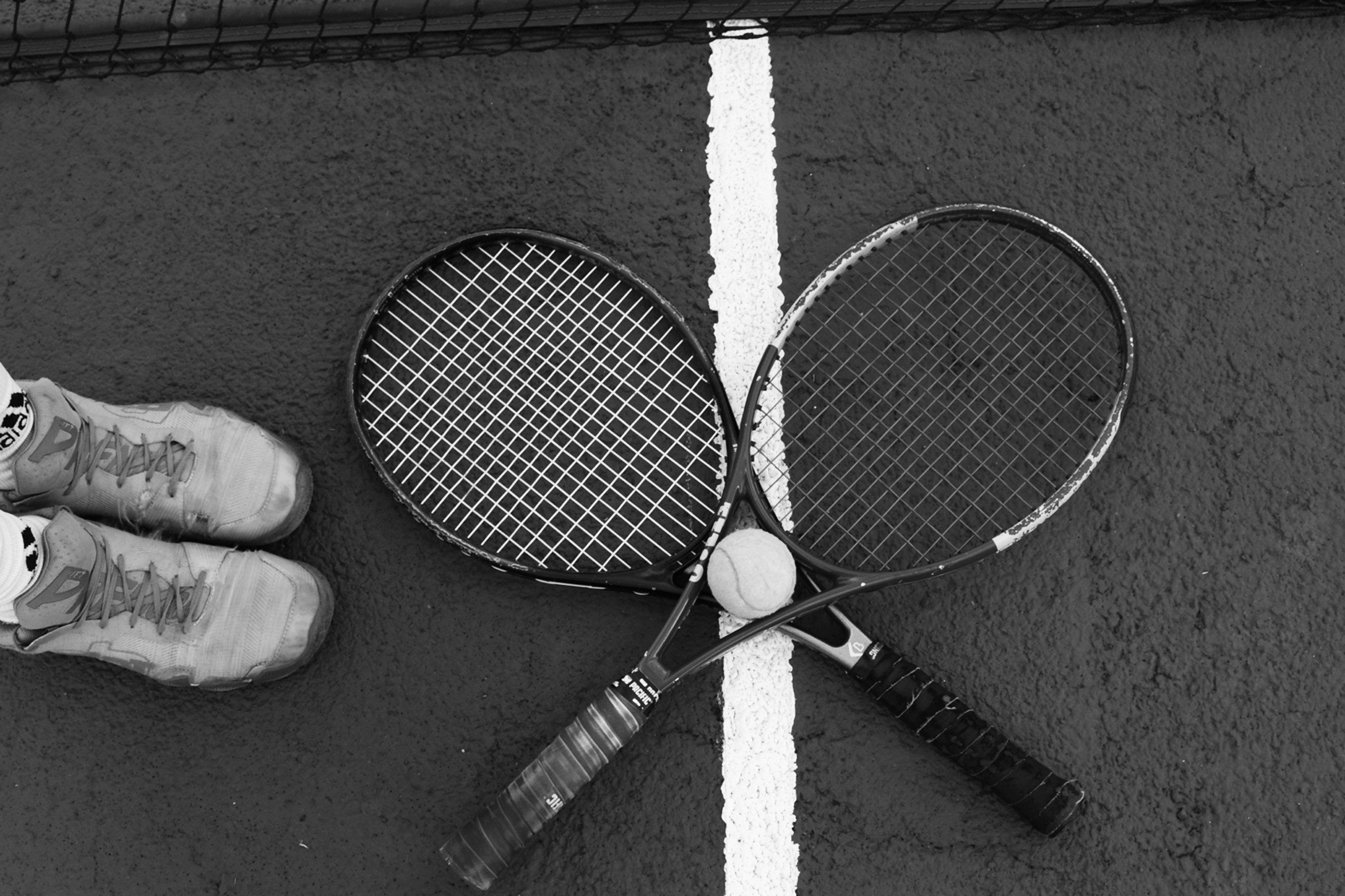 A pair of tennis racquets laying on the ground photo – Free Nairobi ...