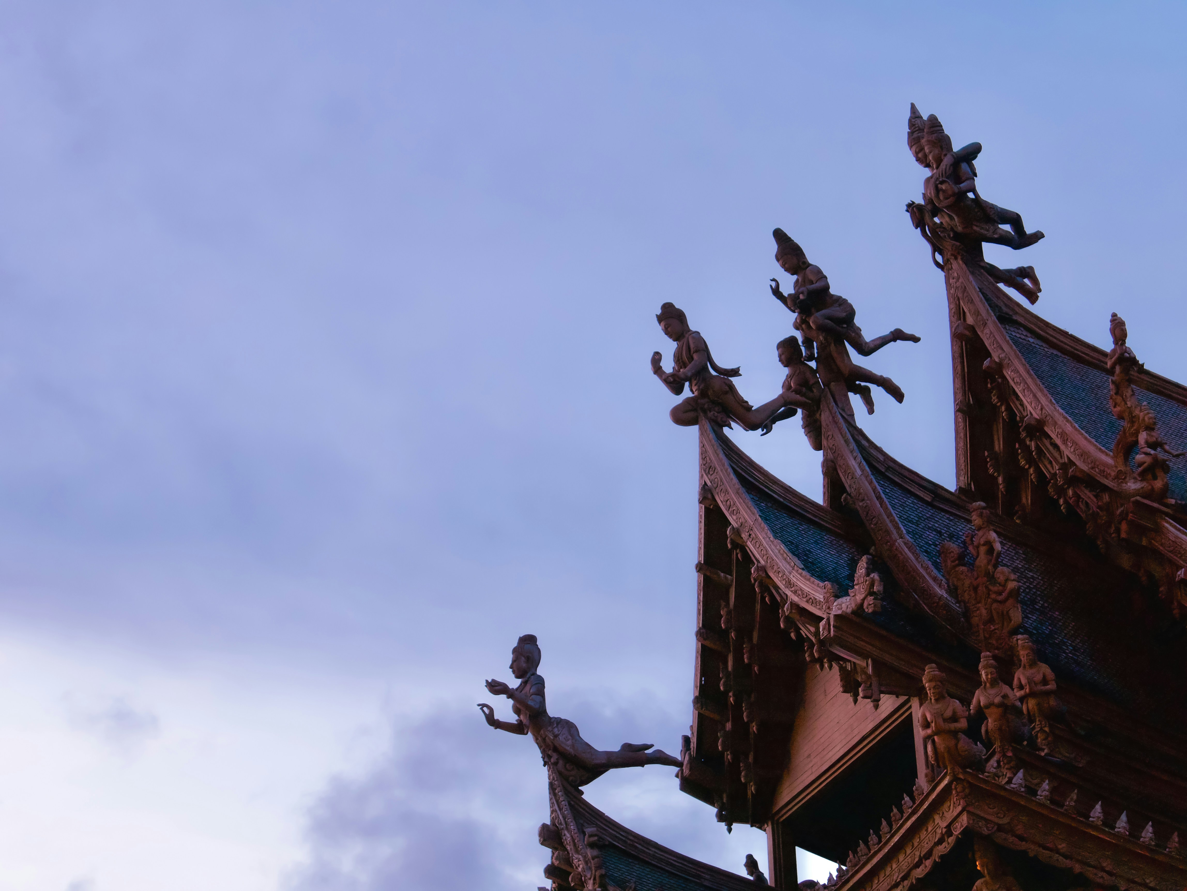 Dragon-Guarded Ridge: Ornate Temple Roof Beneath a Calm Blue Sky