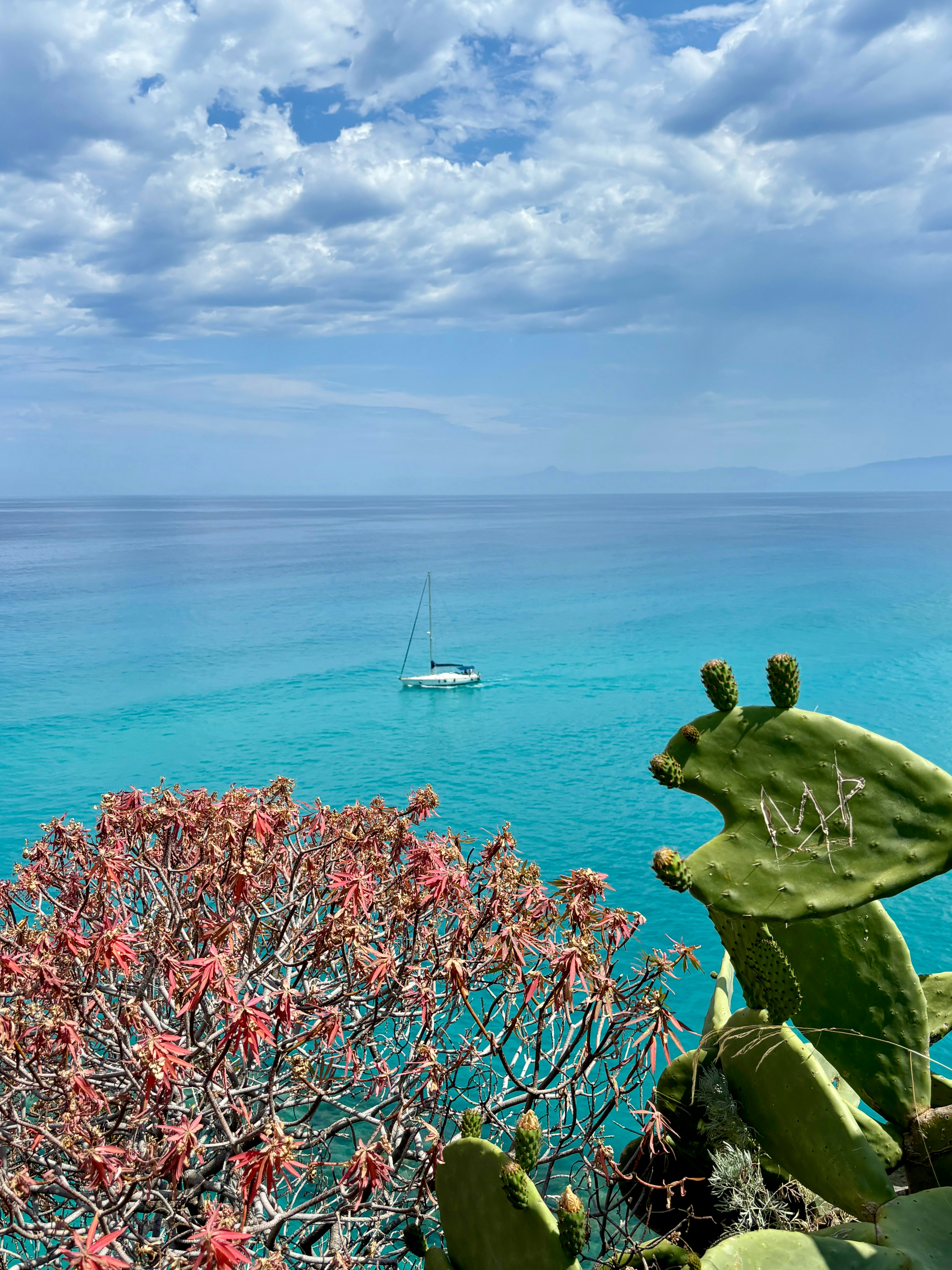 Azure Quiet: Sailboat Whispering to the Sea