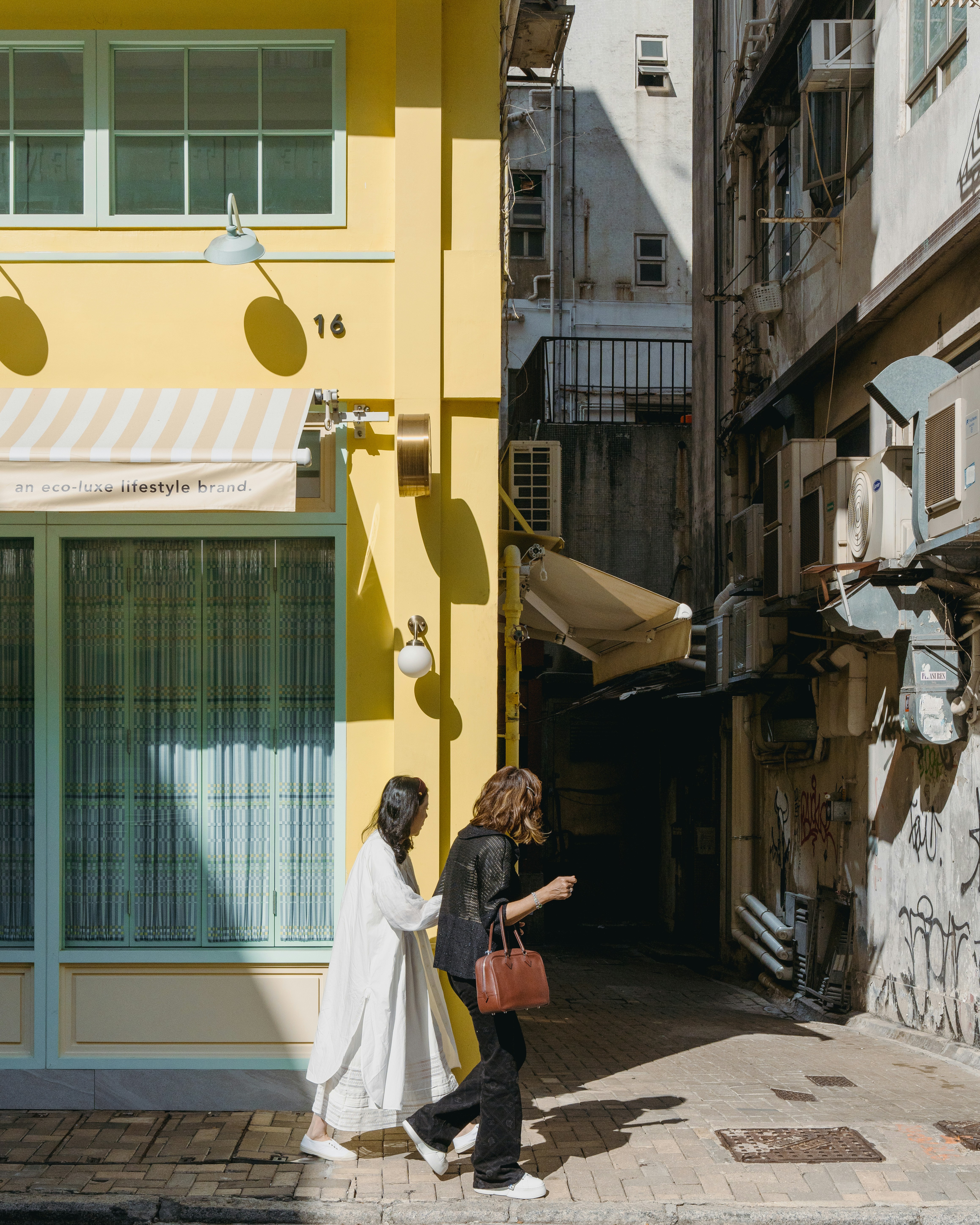 A man and a woman walking down a street