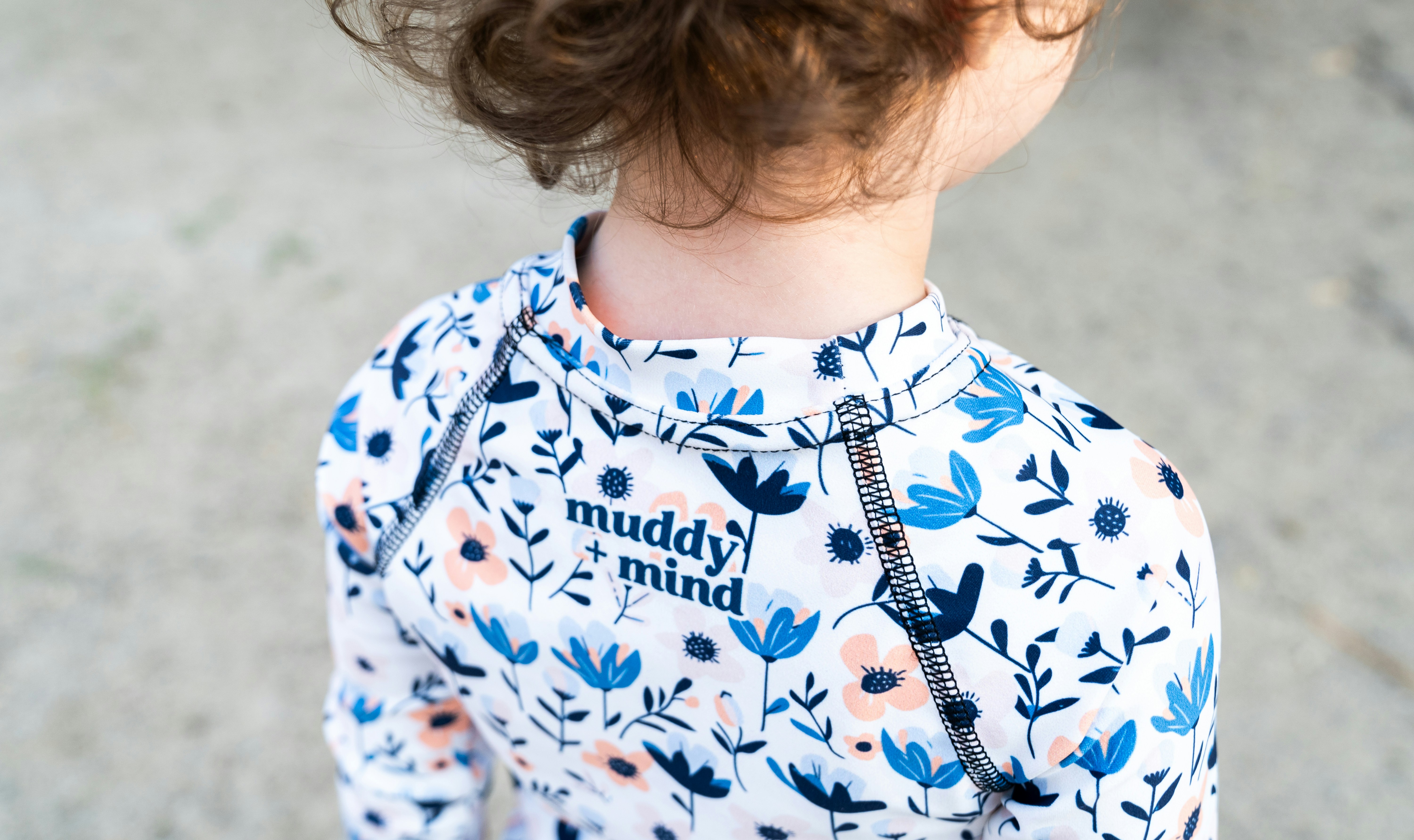 Floral pattern on a swimmer’s rash guard: a child's back as the canvas