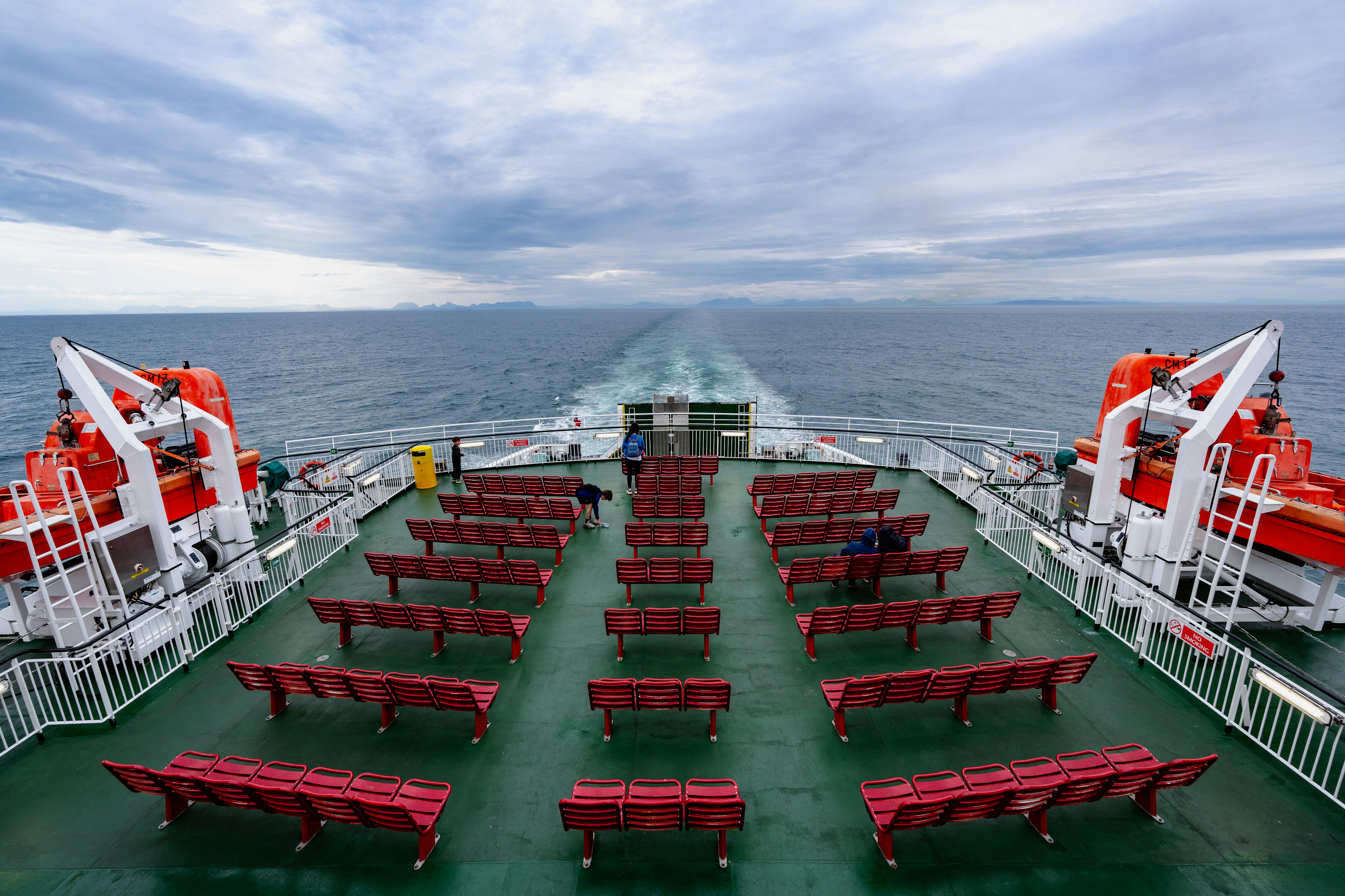 Leading Lines on a Ferry Deck: Red Benches Converging Toward the Distant Horizon