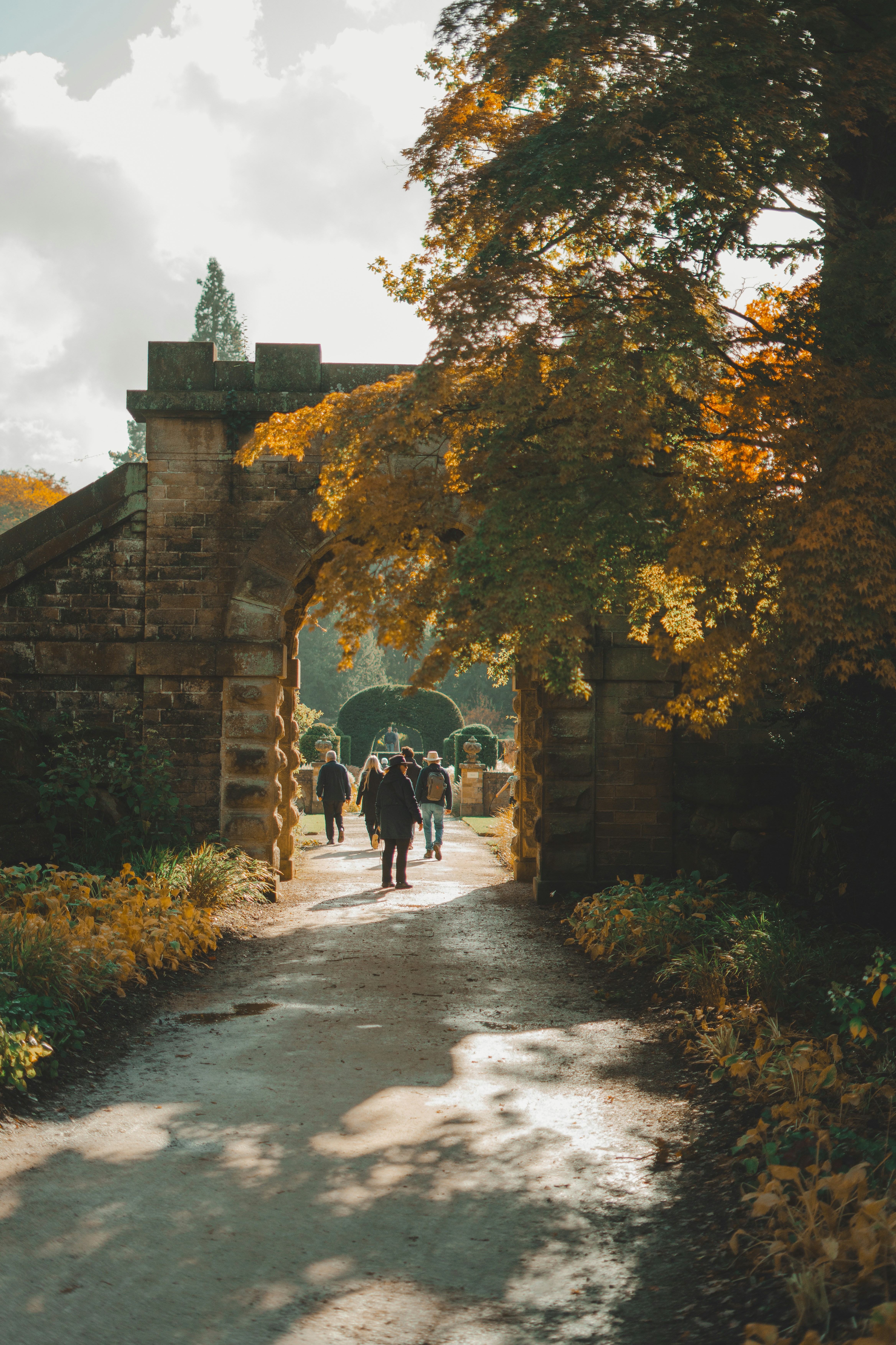 A group of people walking down a pathway photo – Free Path Image on ...