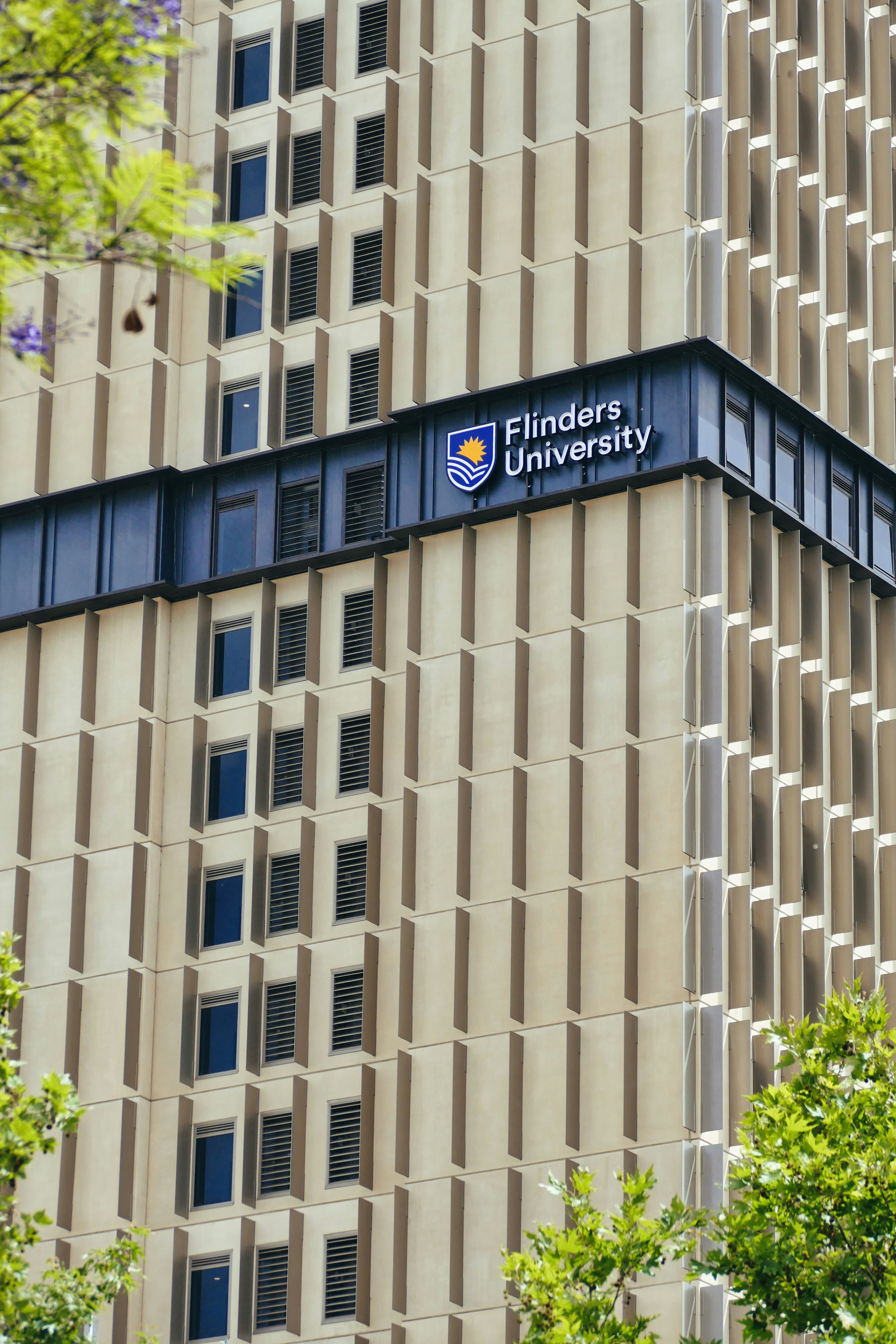 A tall building with a sign on the side of it photo – Free Adelaide sa ...