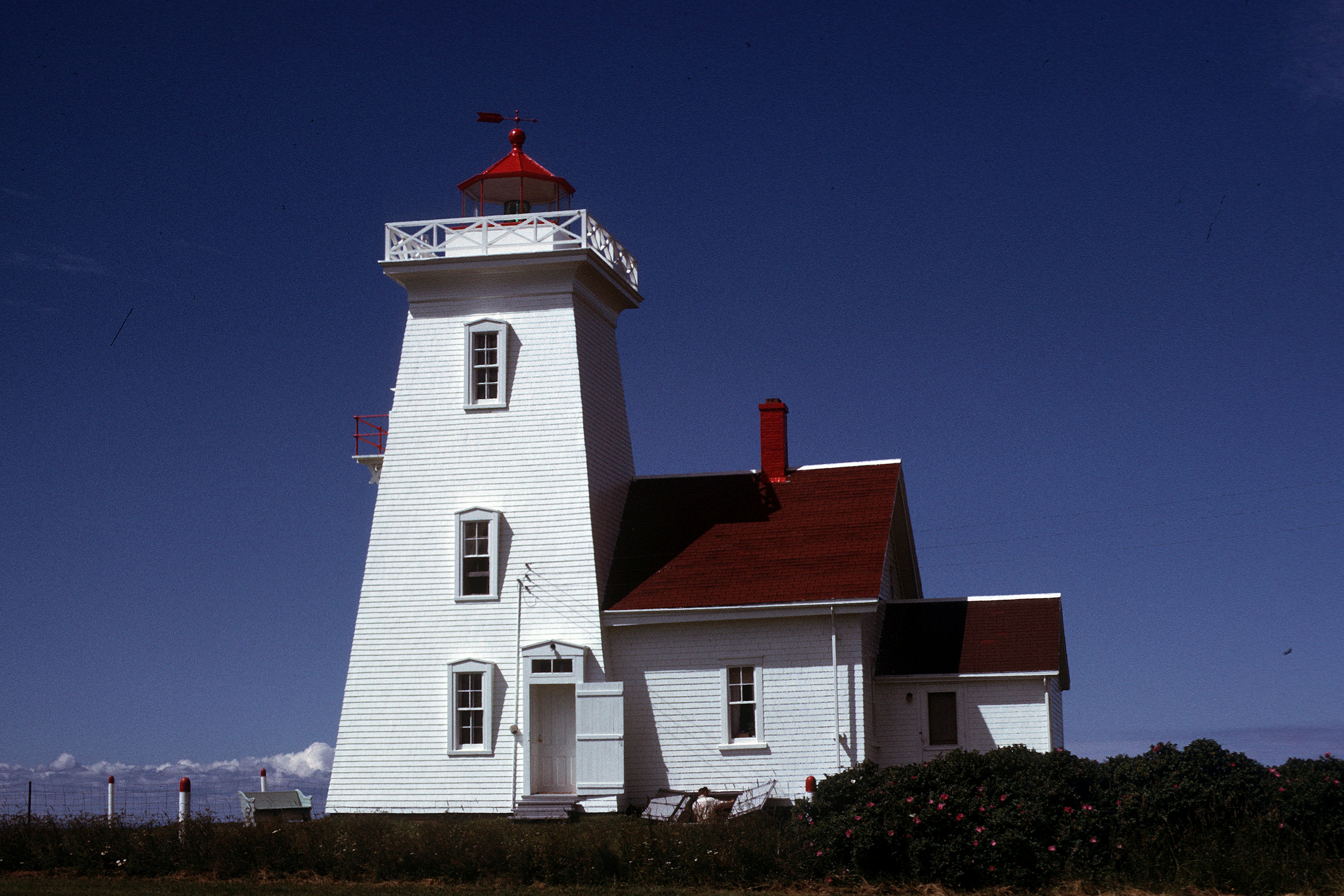 A white lighthouse with a red roof on a clear day photo – Free Port au ...