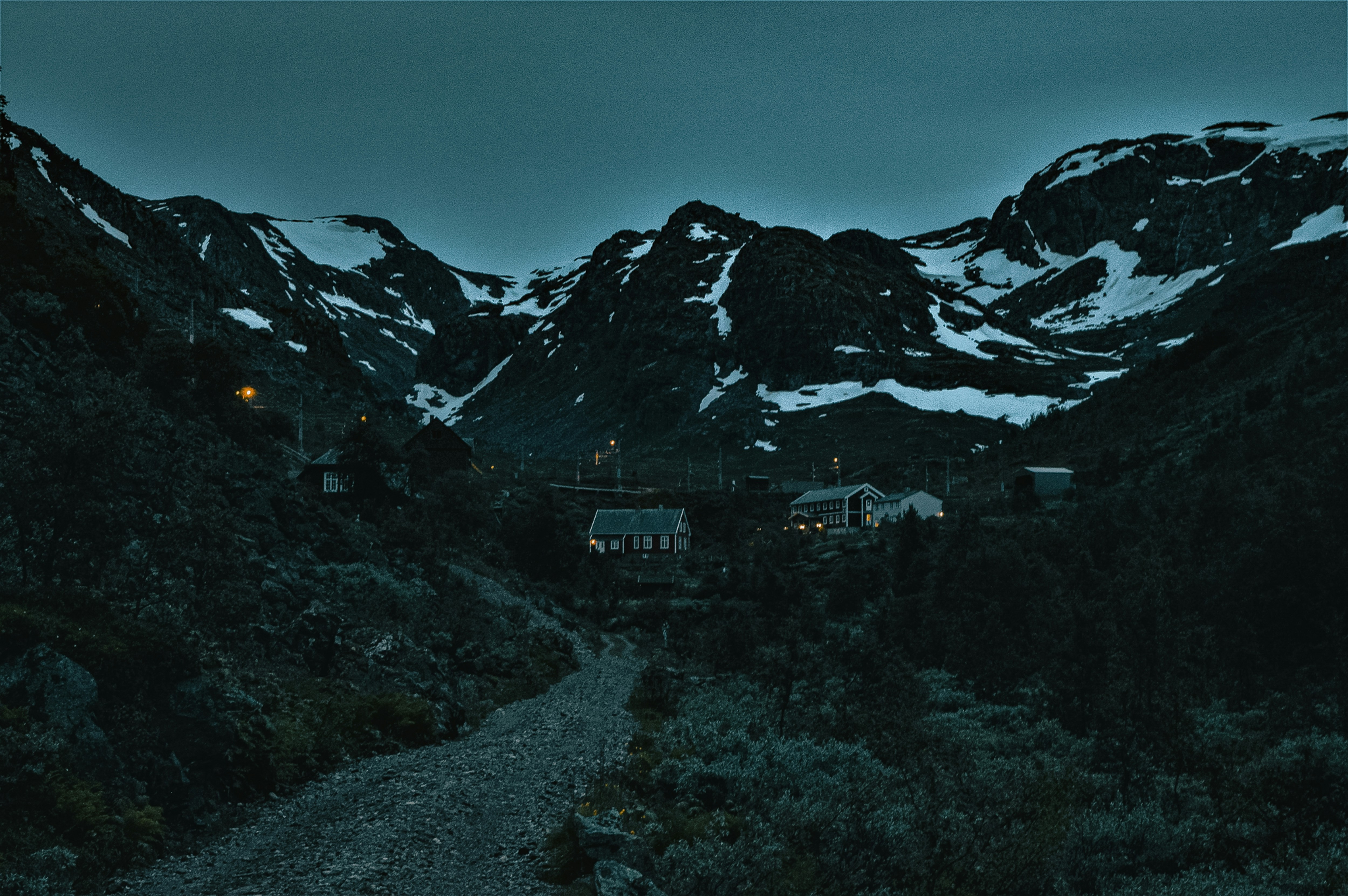 Twilight Trail to a Snow-Dusted Alpine Village