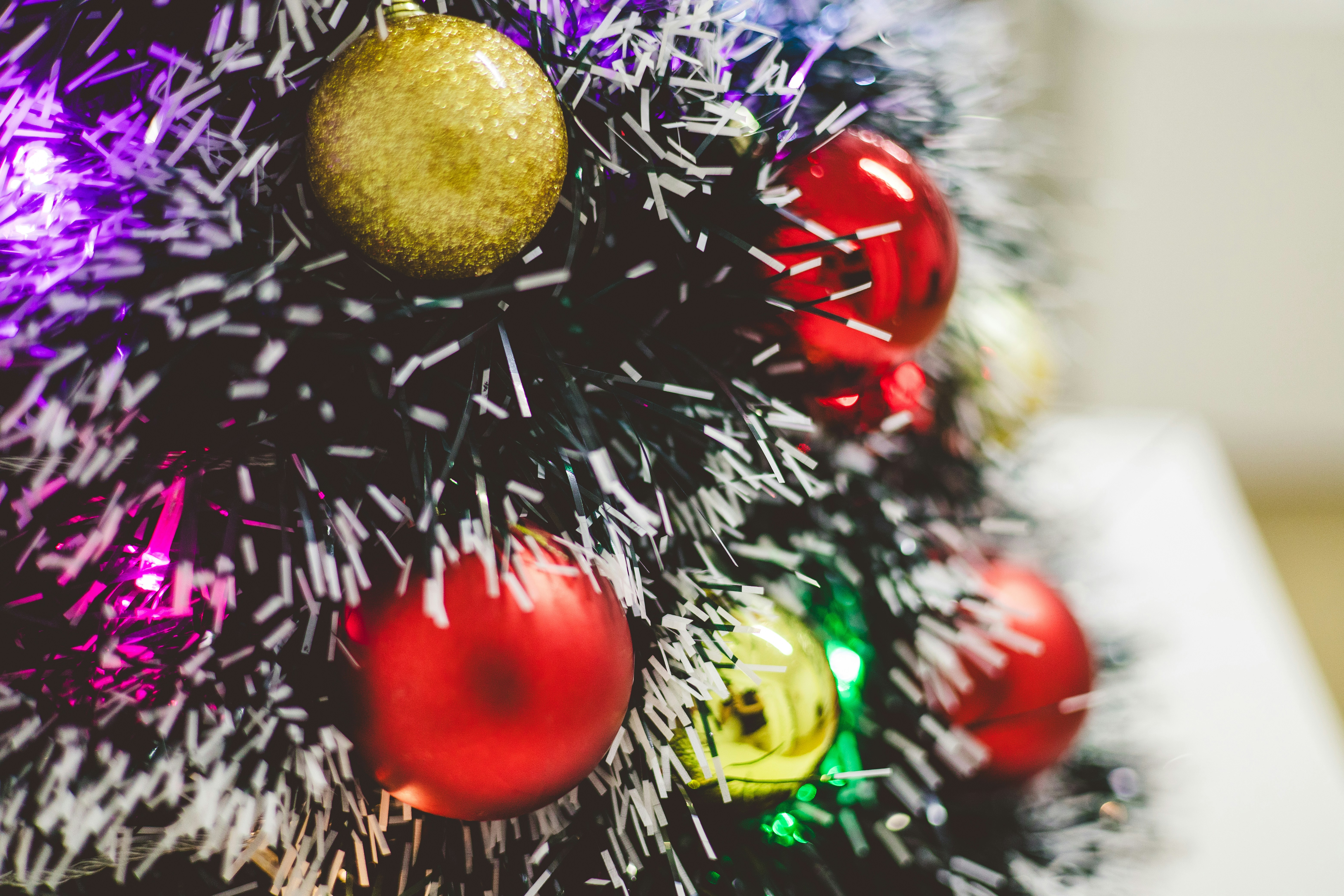 Gilded Orbs Amid Tinsel: A Macro Christmas Close-Up