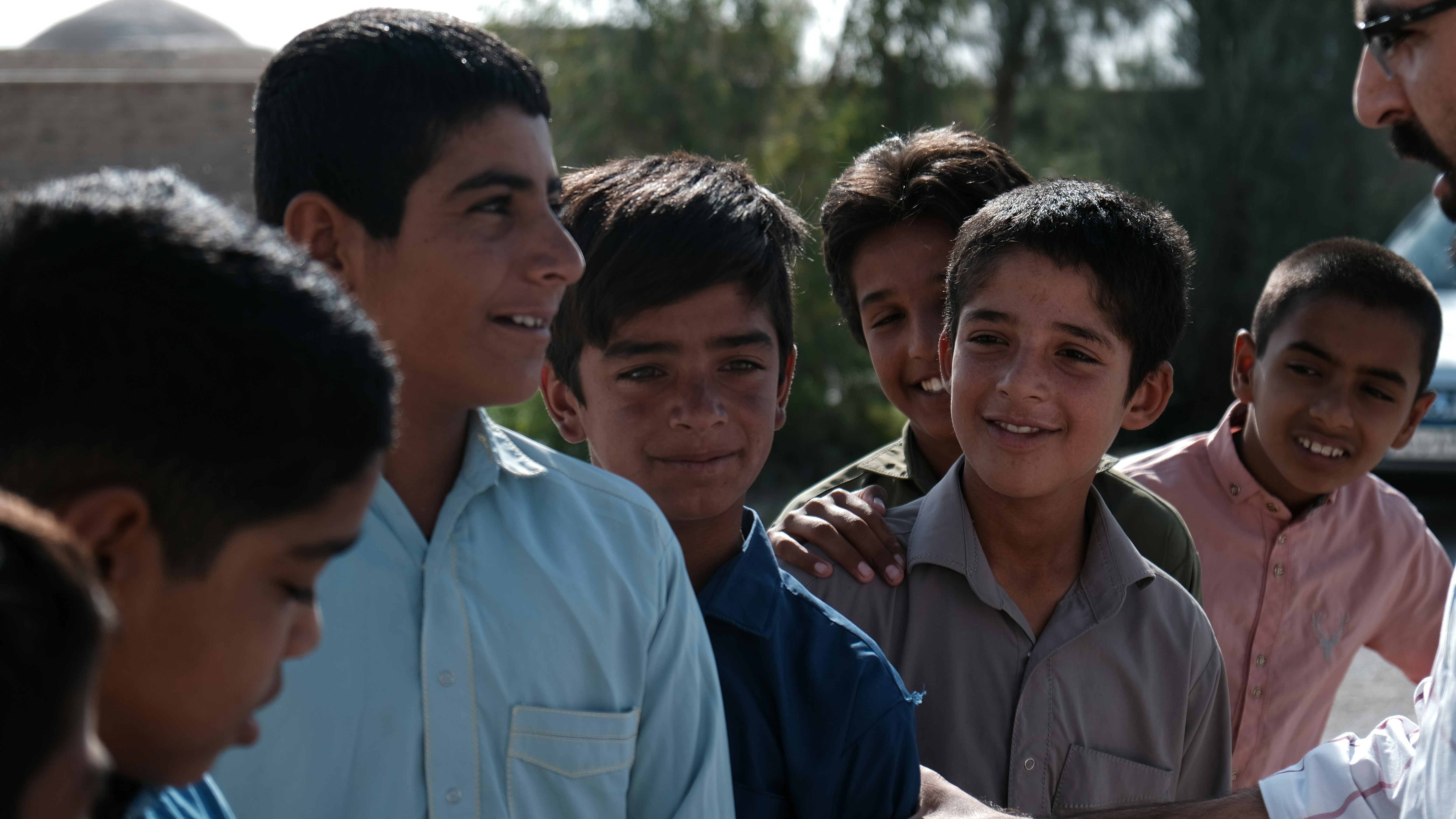 Sistani students laugh on the first day of the rural school's reopening