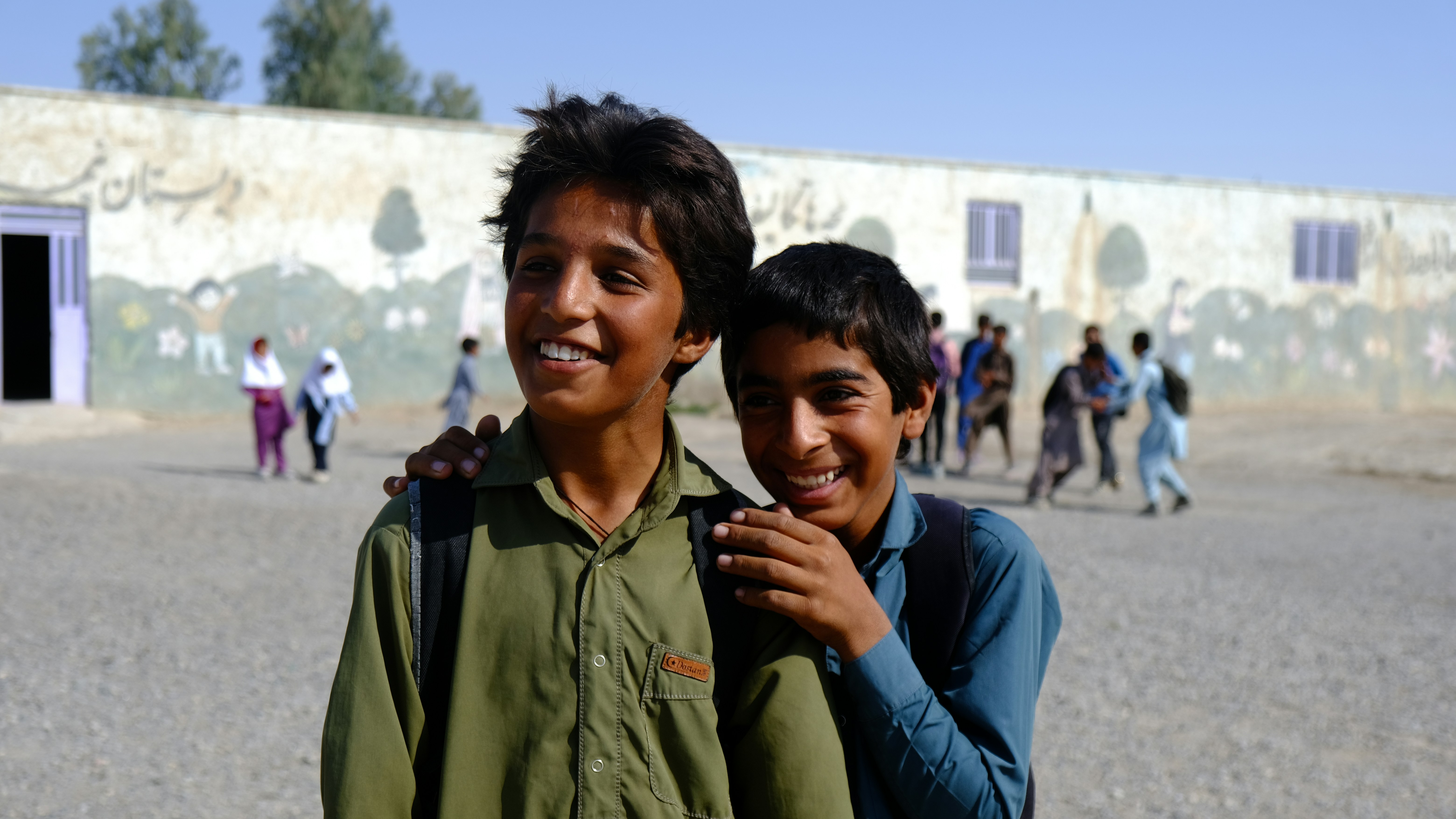 Laughter in the Graffiti Courtyard: Two Friends Share a Moment