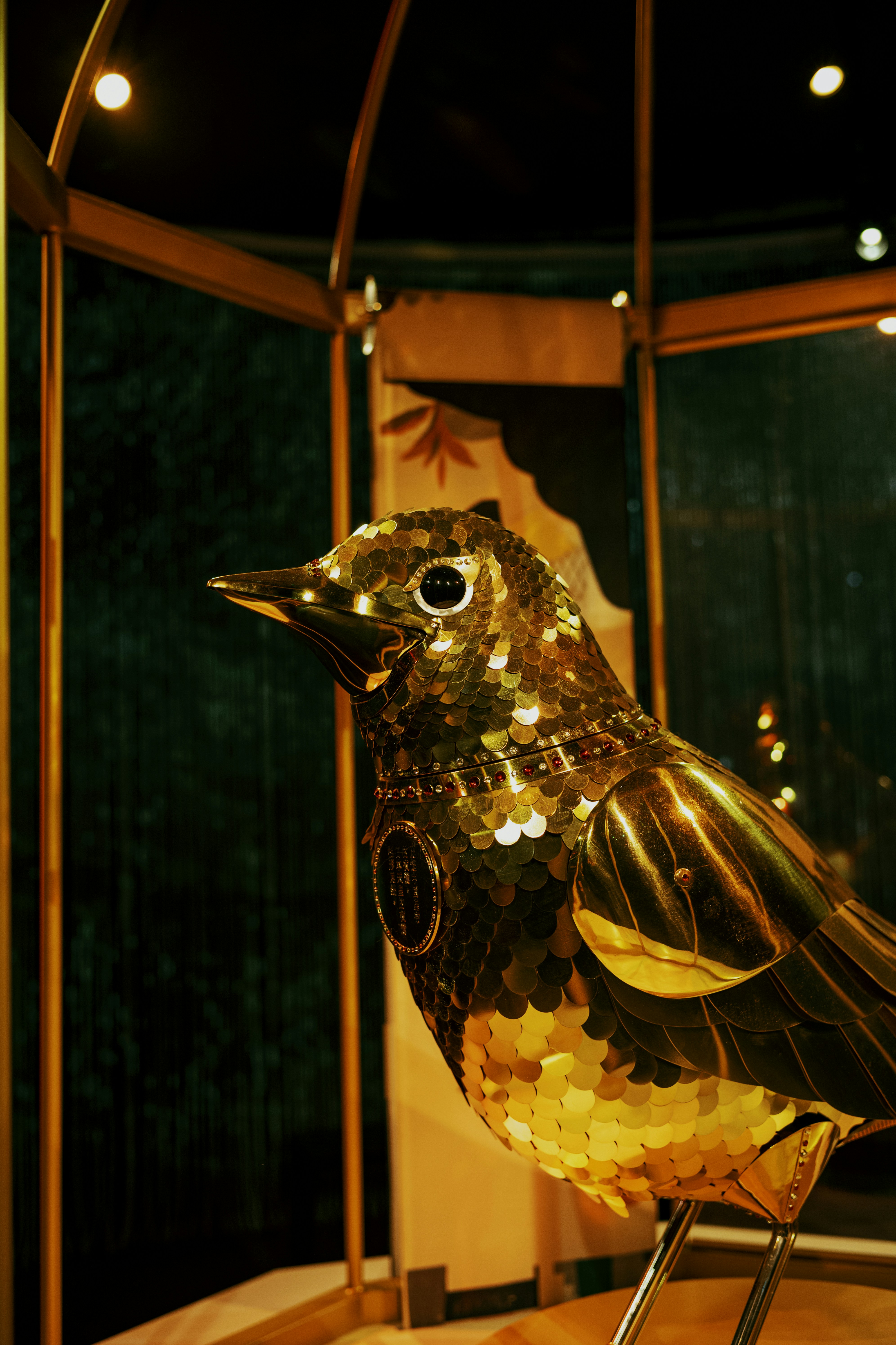 Gilded Echo: A Metal Songbird in a Glass Case