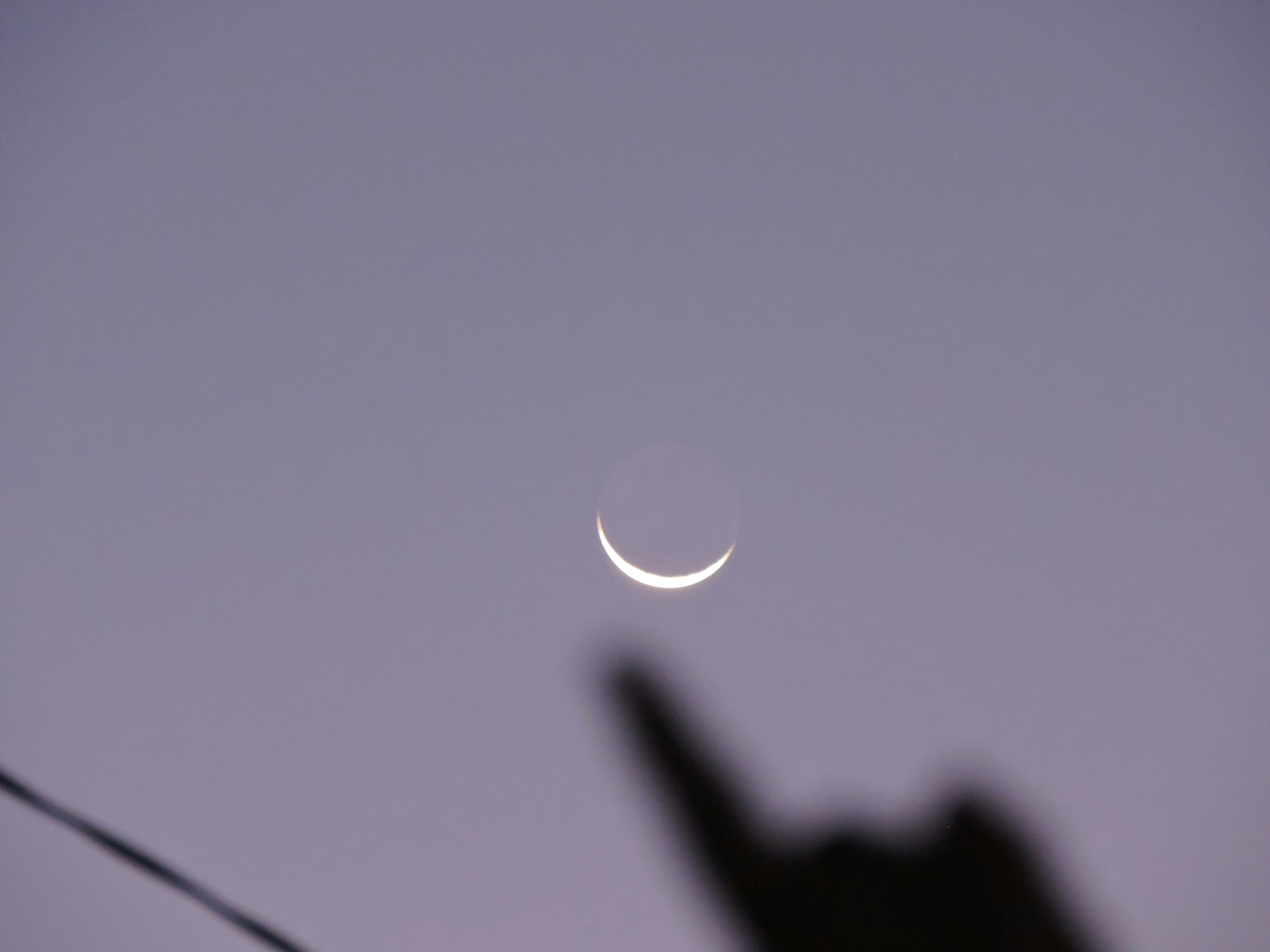 Crescent Focus: Night Sky Window toward a Blurred Fingered Silhouette
