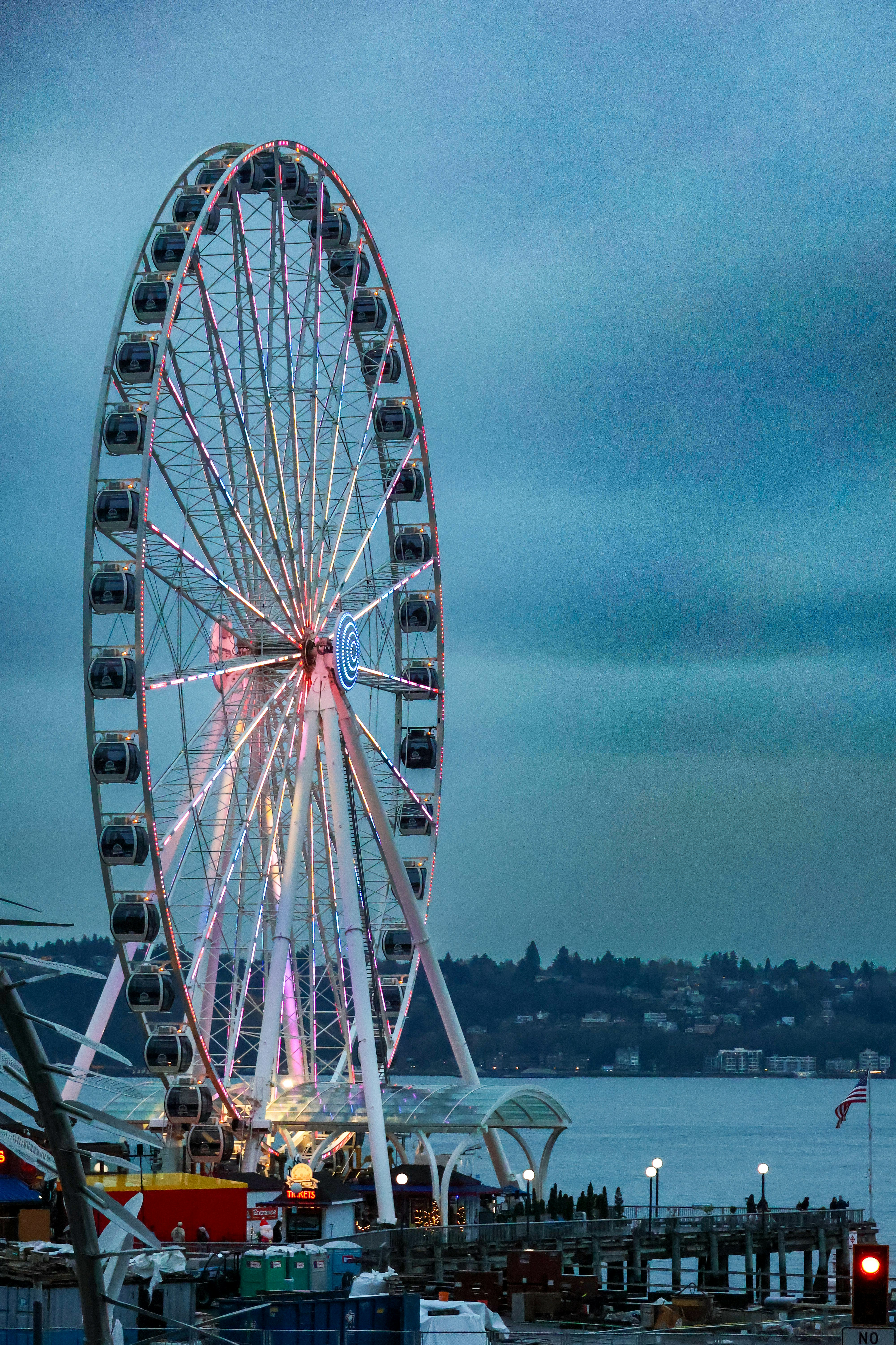 Neon-lit Ferris Wheel Framing a Misty Waterfront at Dusk