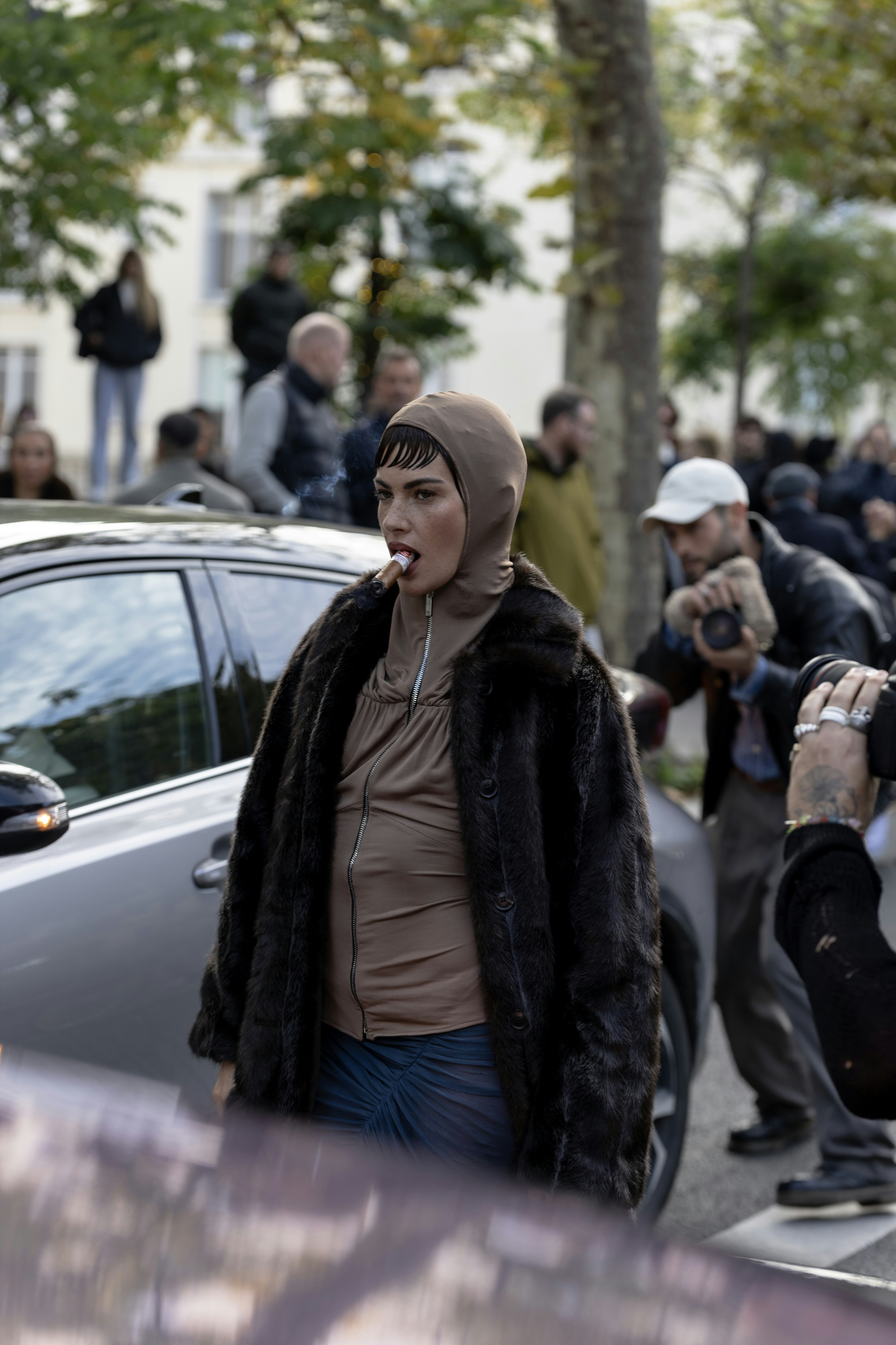 A group of people standing around a car photo – Free Paris Image on ...
