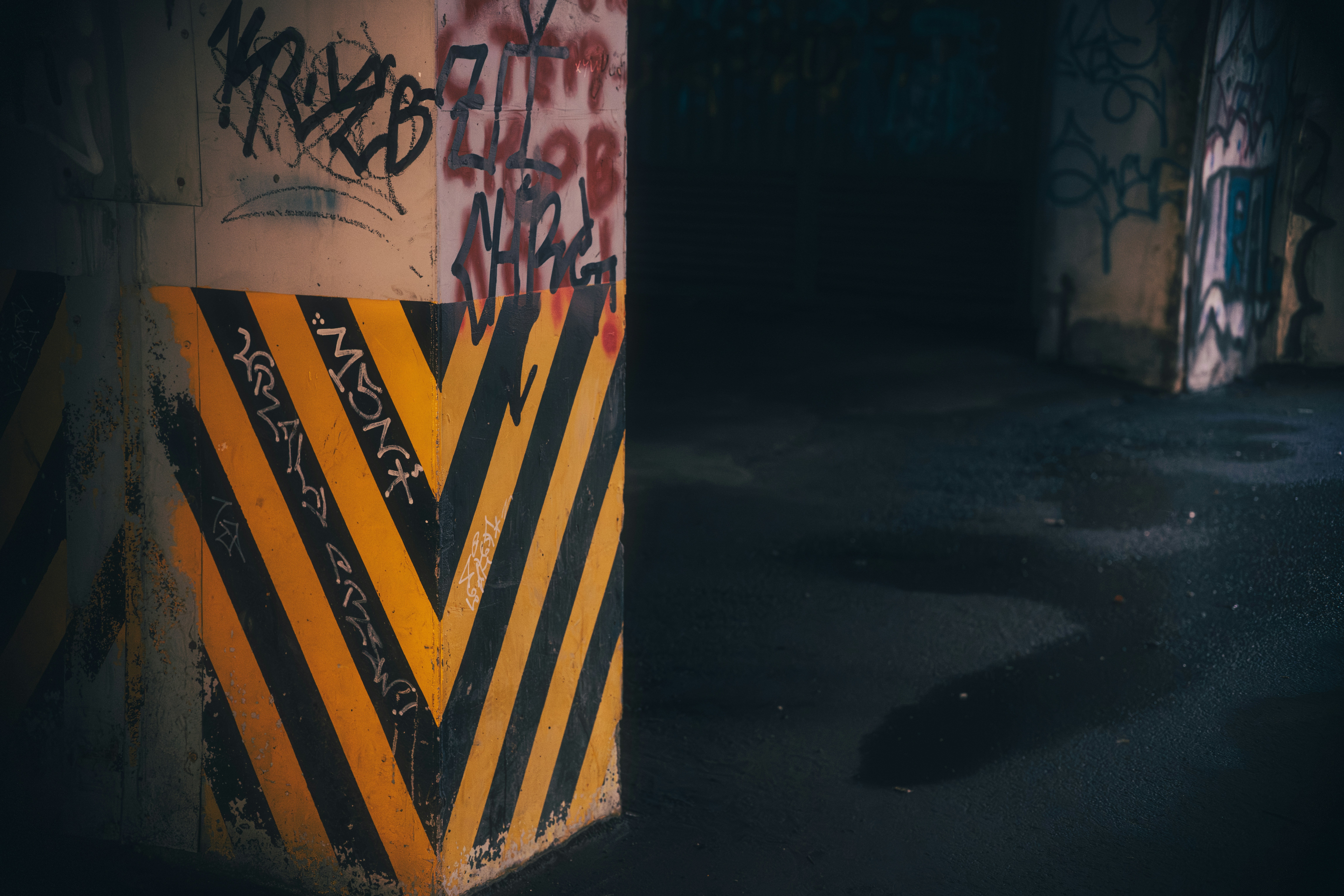 A yellow and black pole with graffiti on it photo – Free Black Image on ...