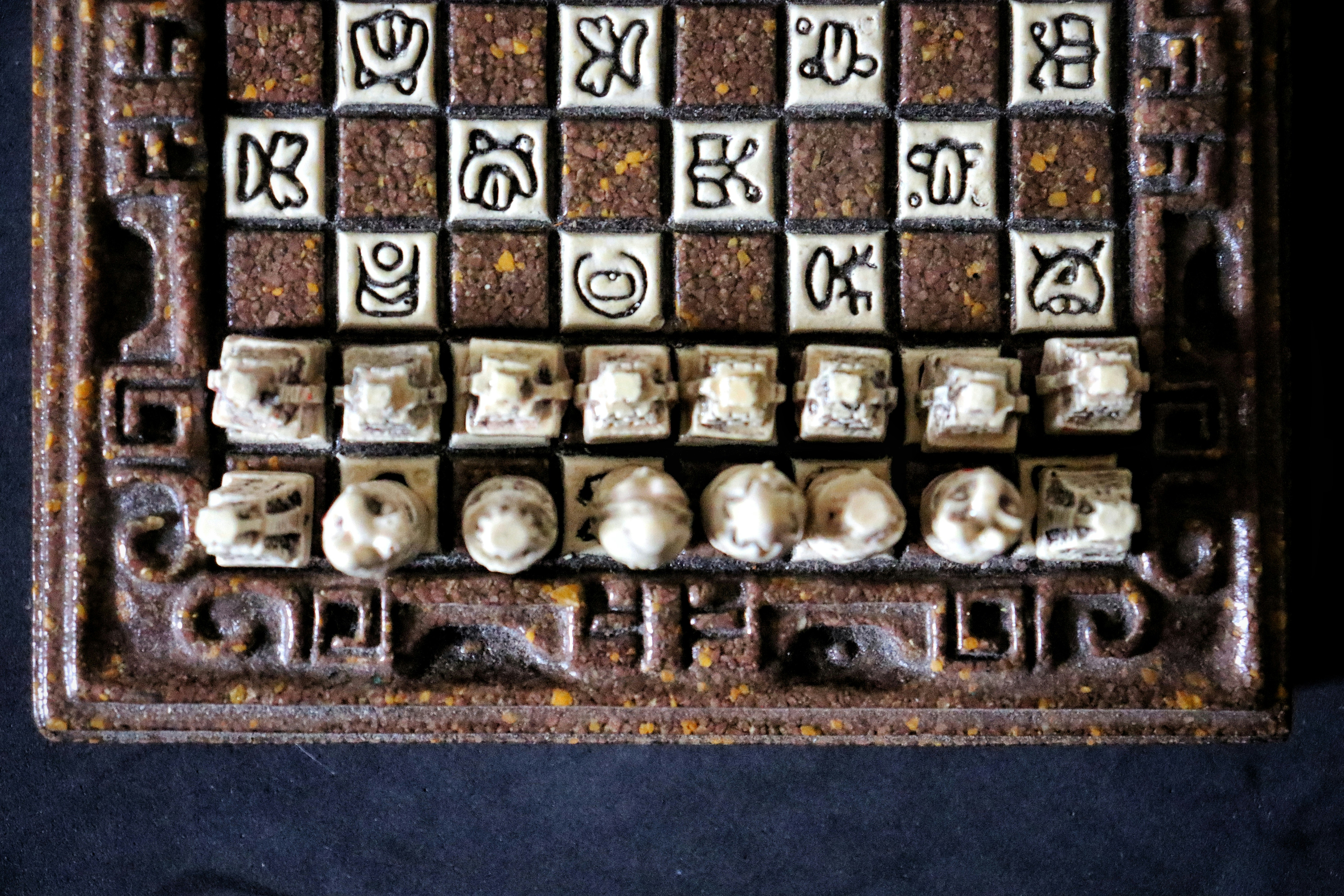 Rust and Rune Grid: a close-up of a carved glyph relic