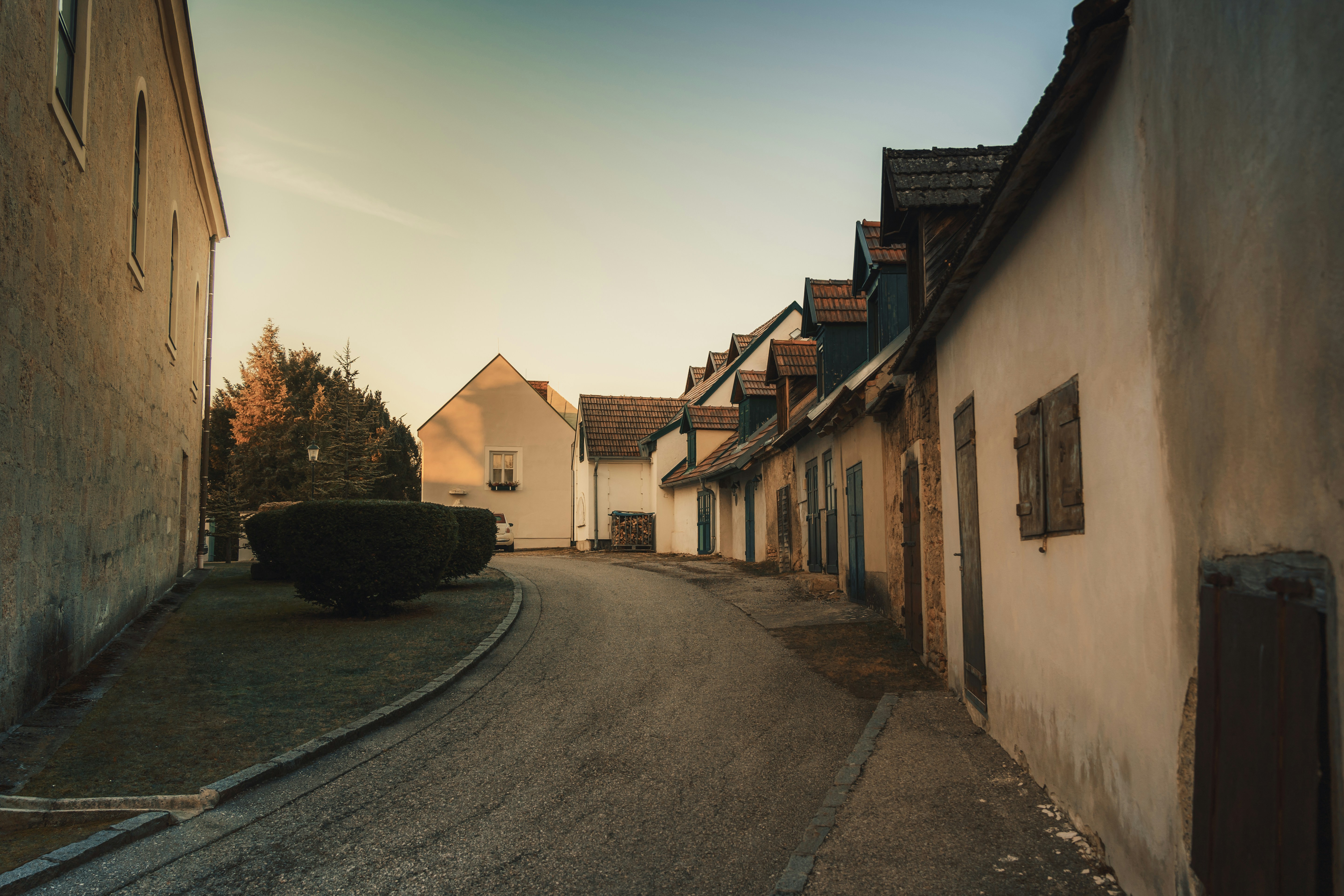 Quiet European Lane with Curving Road and Row of White Facades