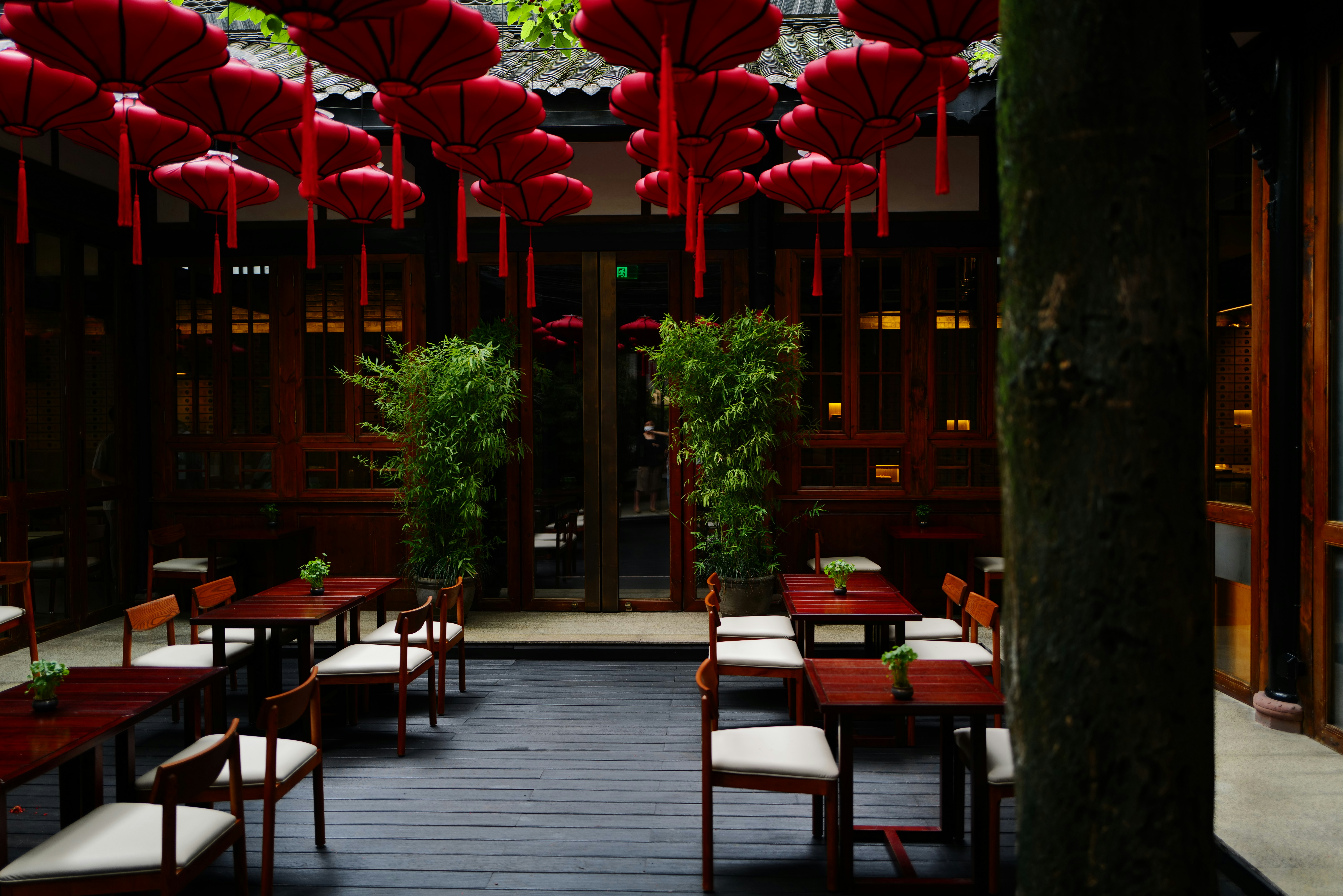Crimson Lantern Corridor: Quiet Courtyard Dining Under Red Orbs