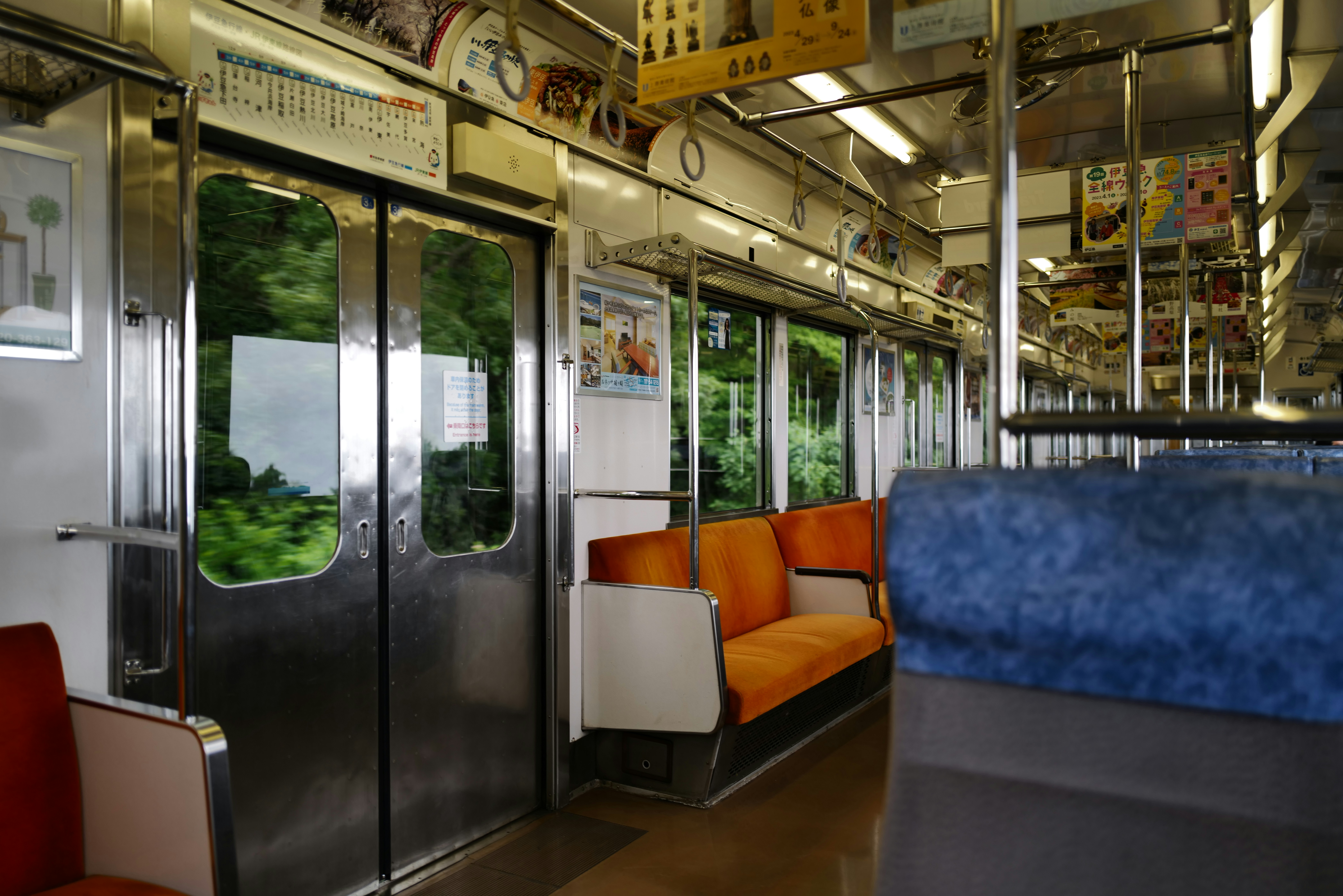 Mid-ride Serenity: Orange Seats Framed by Stainless Subway Car