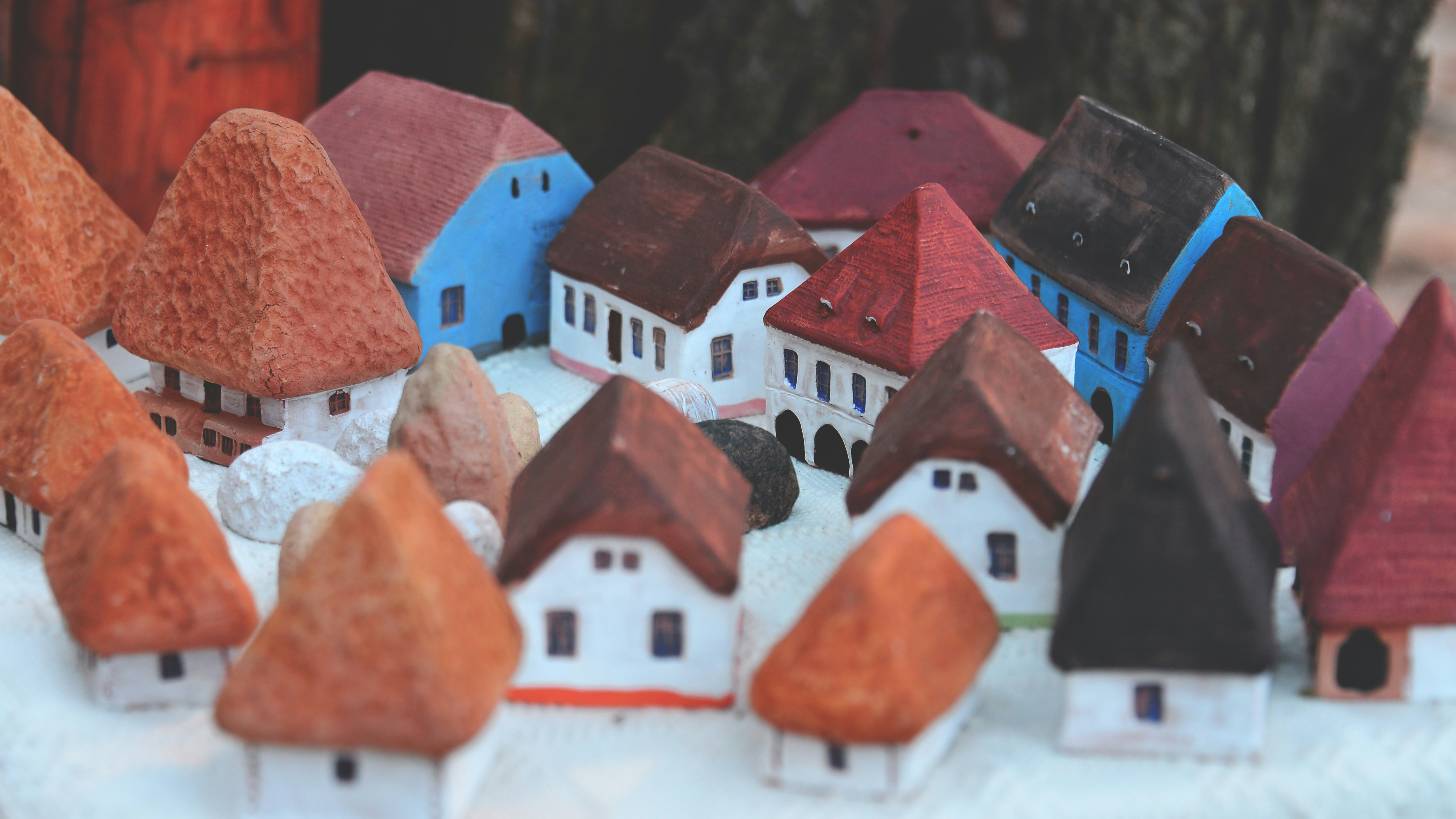 Model village with colorful rooftops nestled in snow.