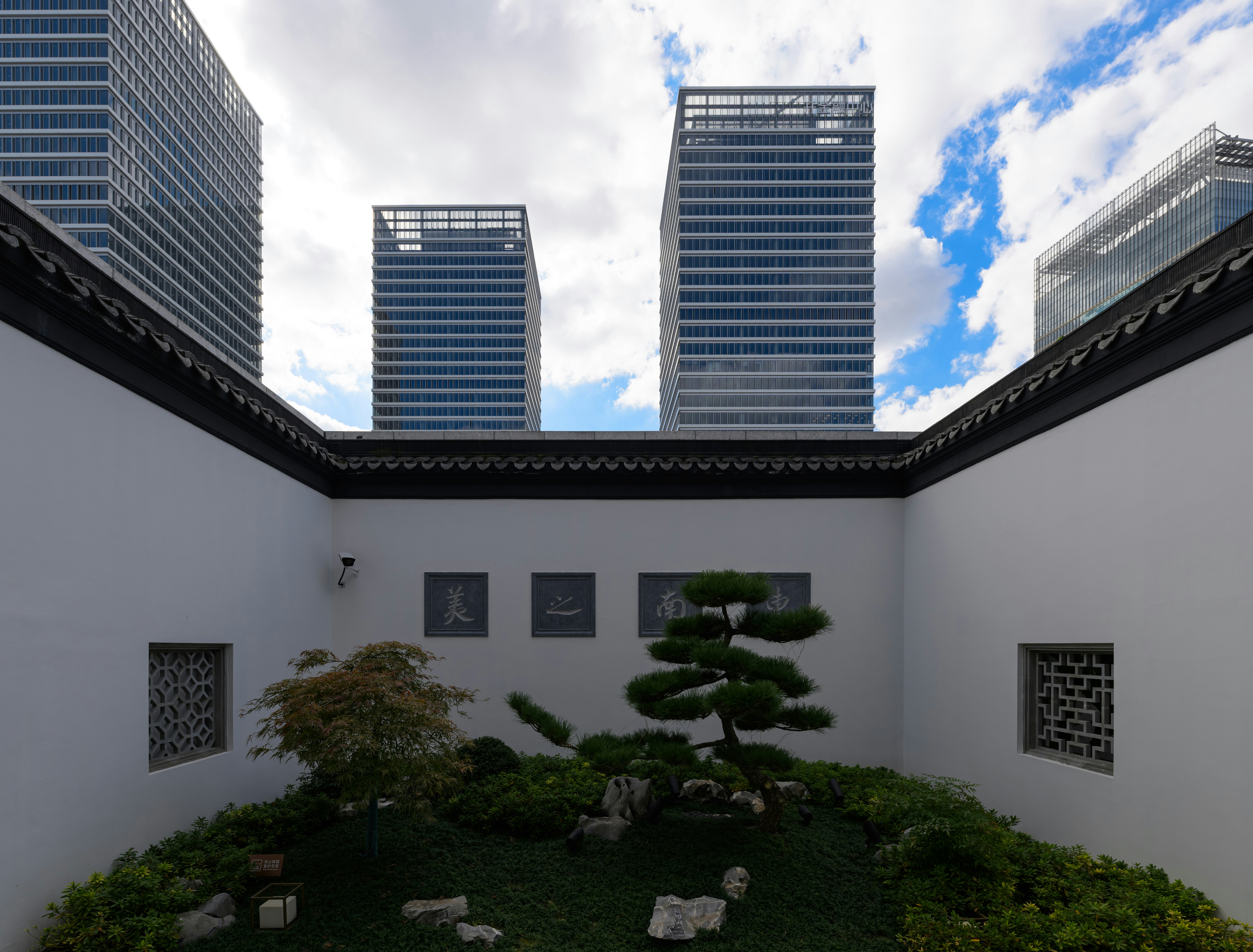 A courtyard with a small tree in the middle of it photo – Free Pudong ...