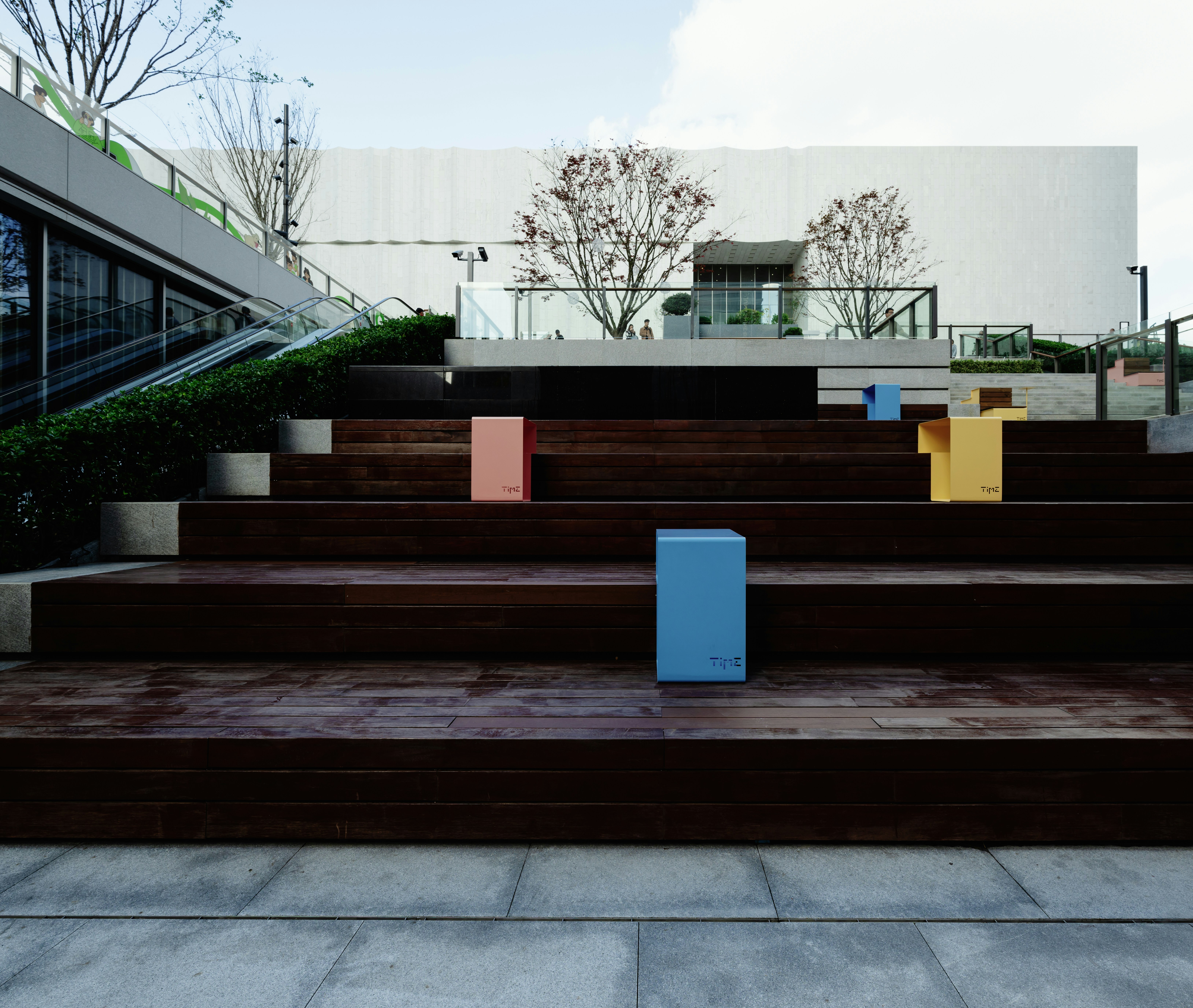 Blue Beacon on the Tiered Steps: A Minimalist Playground of Color