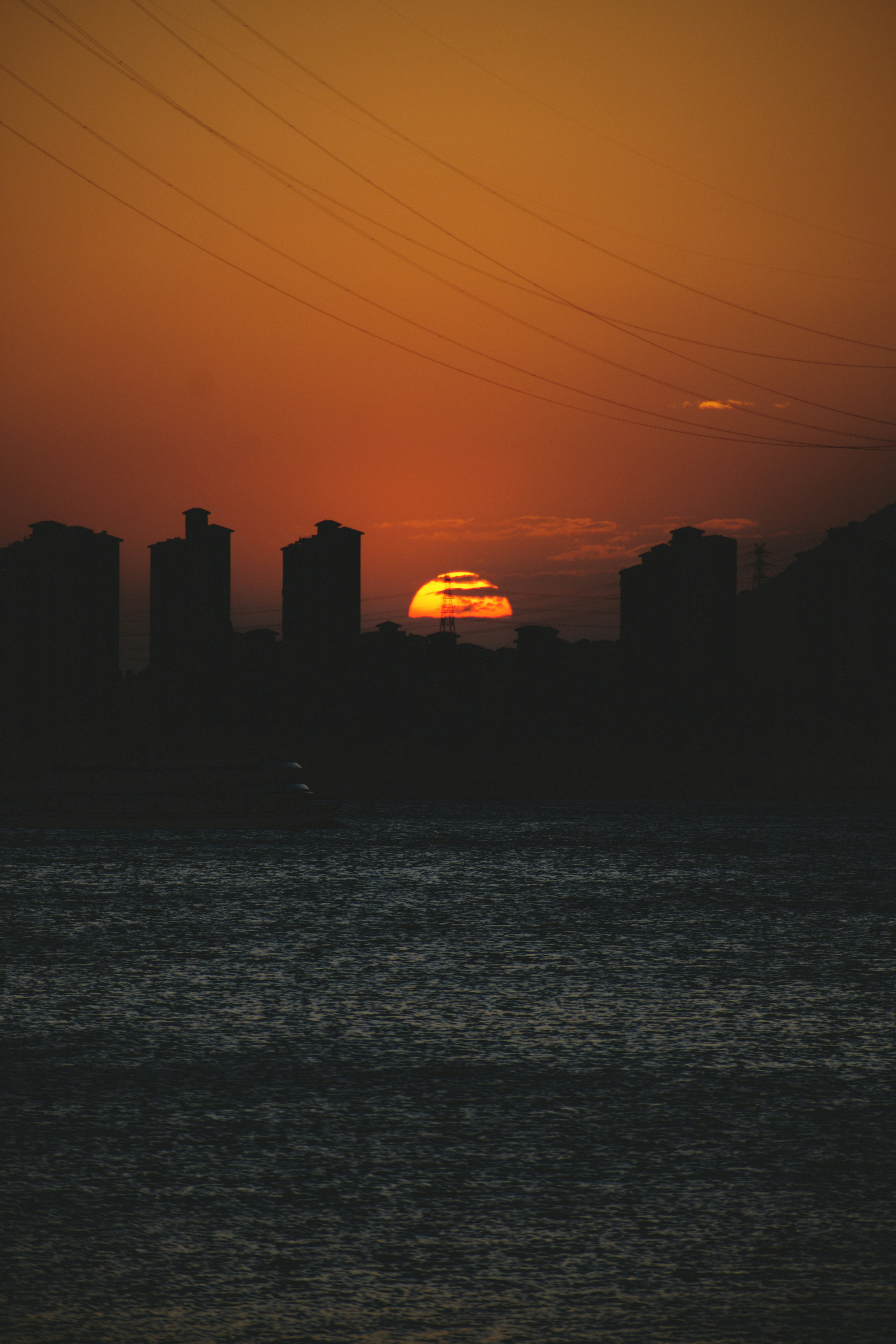 The sun is setting over the city skyline photo – Free Nature Image on ...