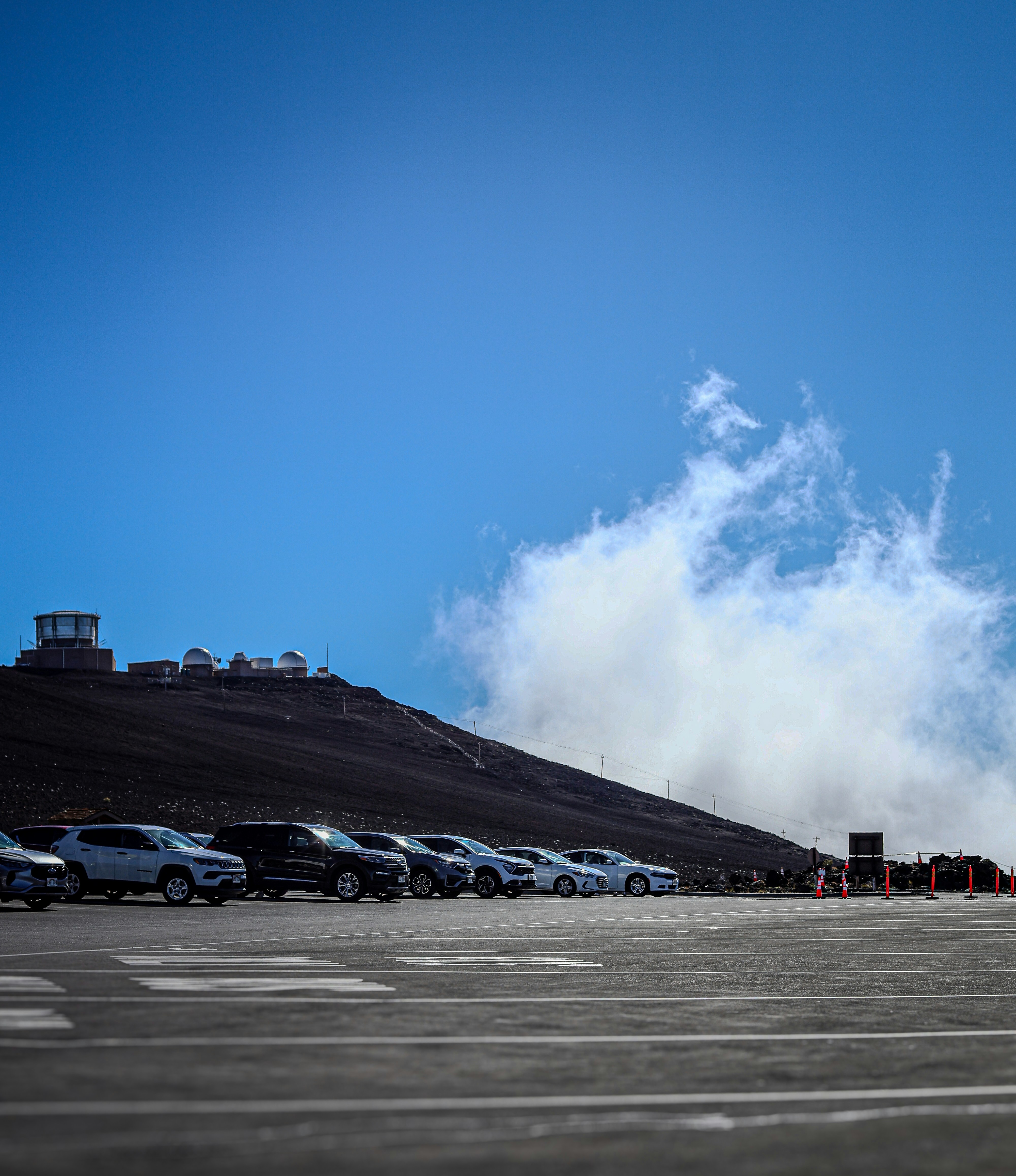 Blue Sky Over the Observatory Ridge Beside a Row of Parked Cars