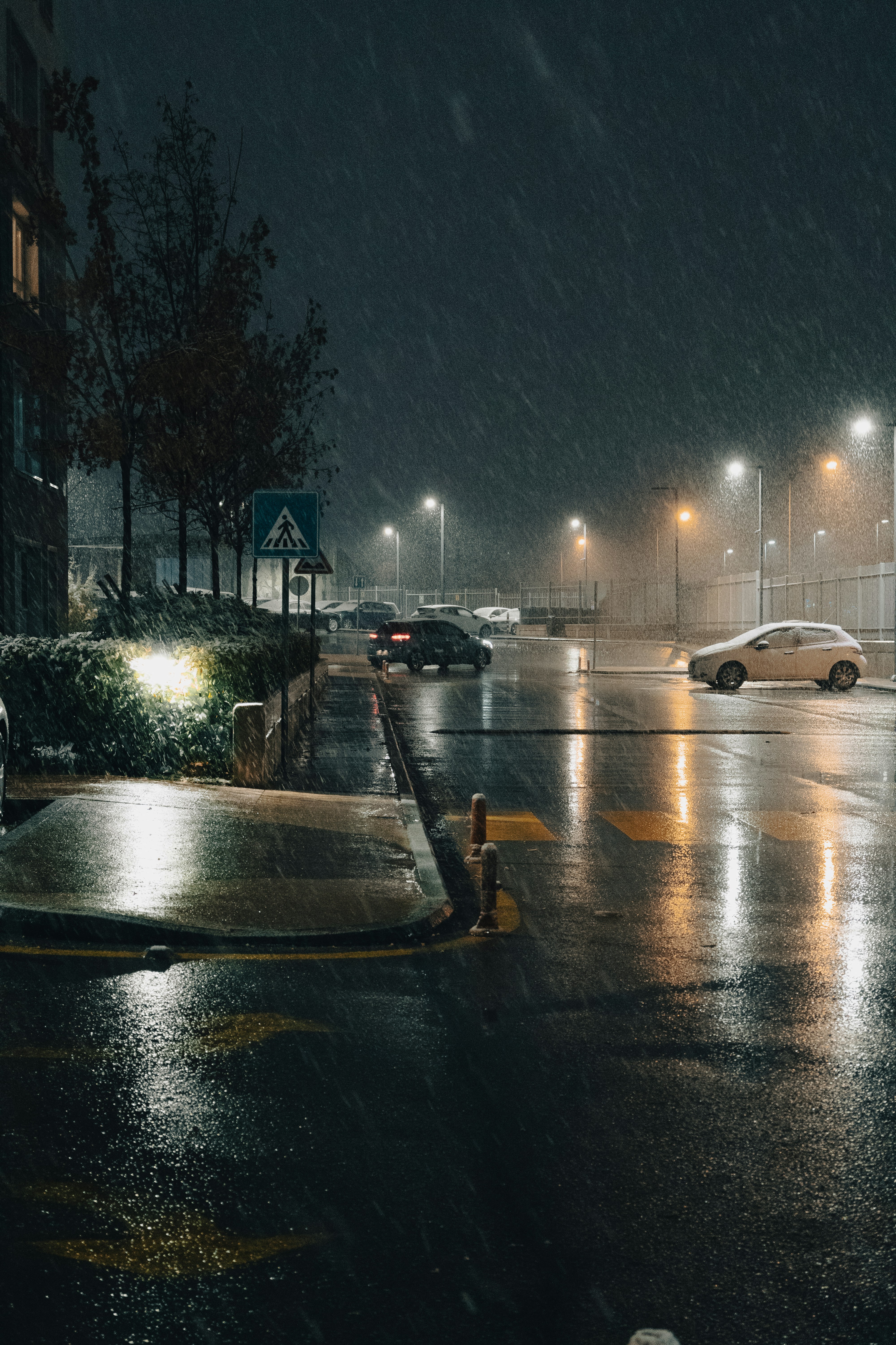 A city street at night in the rain