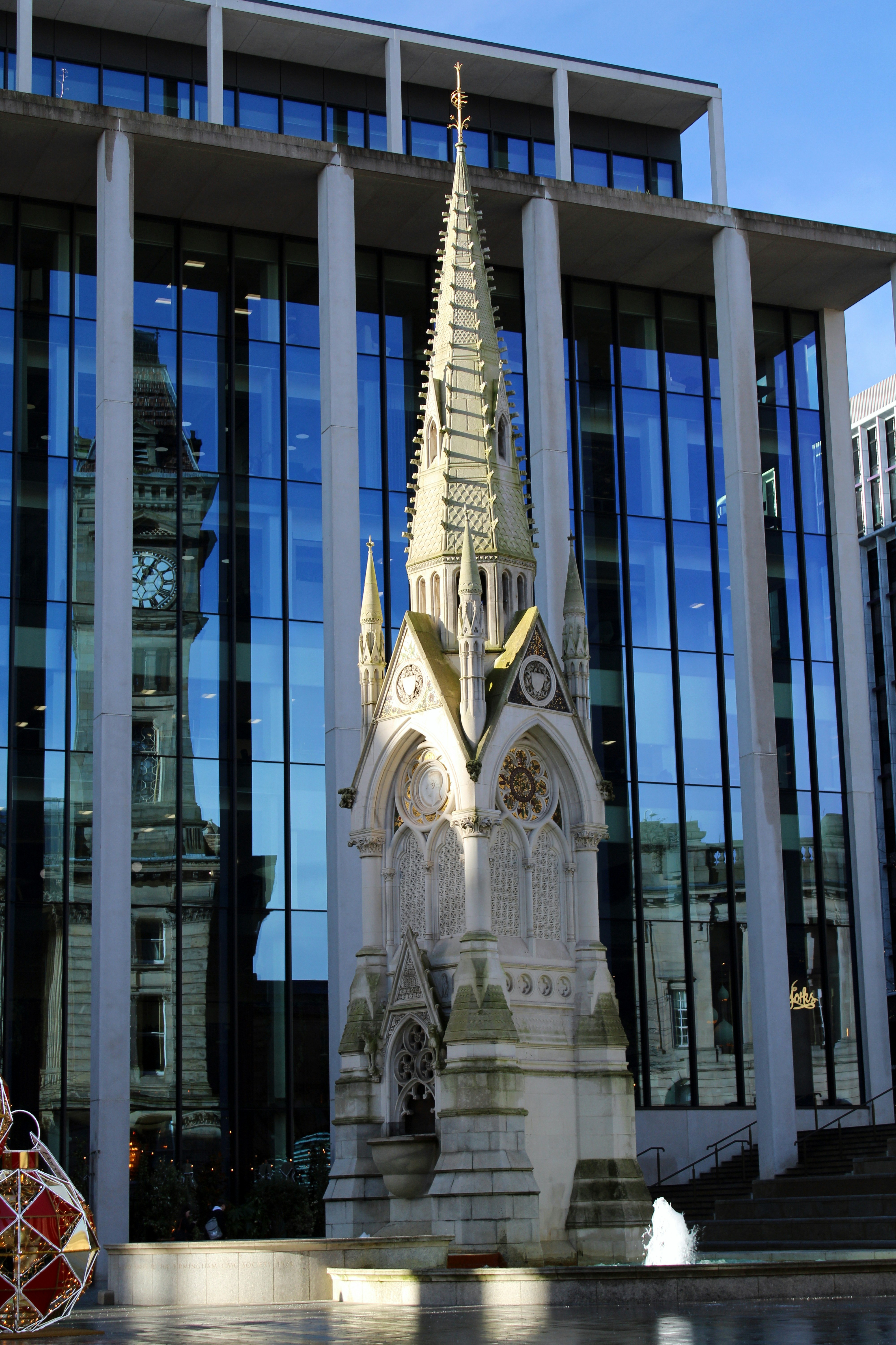 Spire in the Glass: A Gothic Needle Between Modern Facades