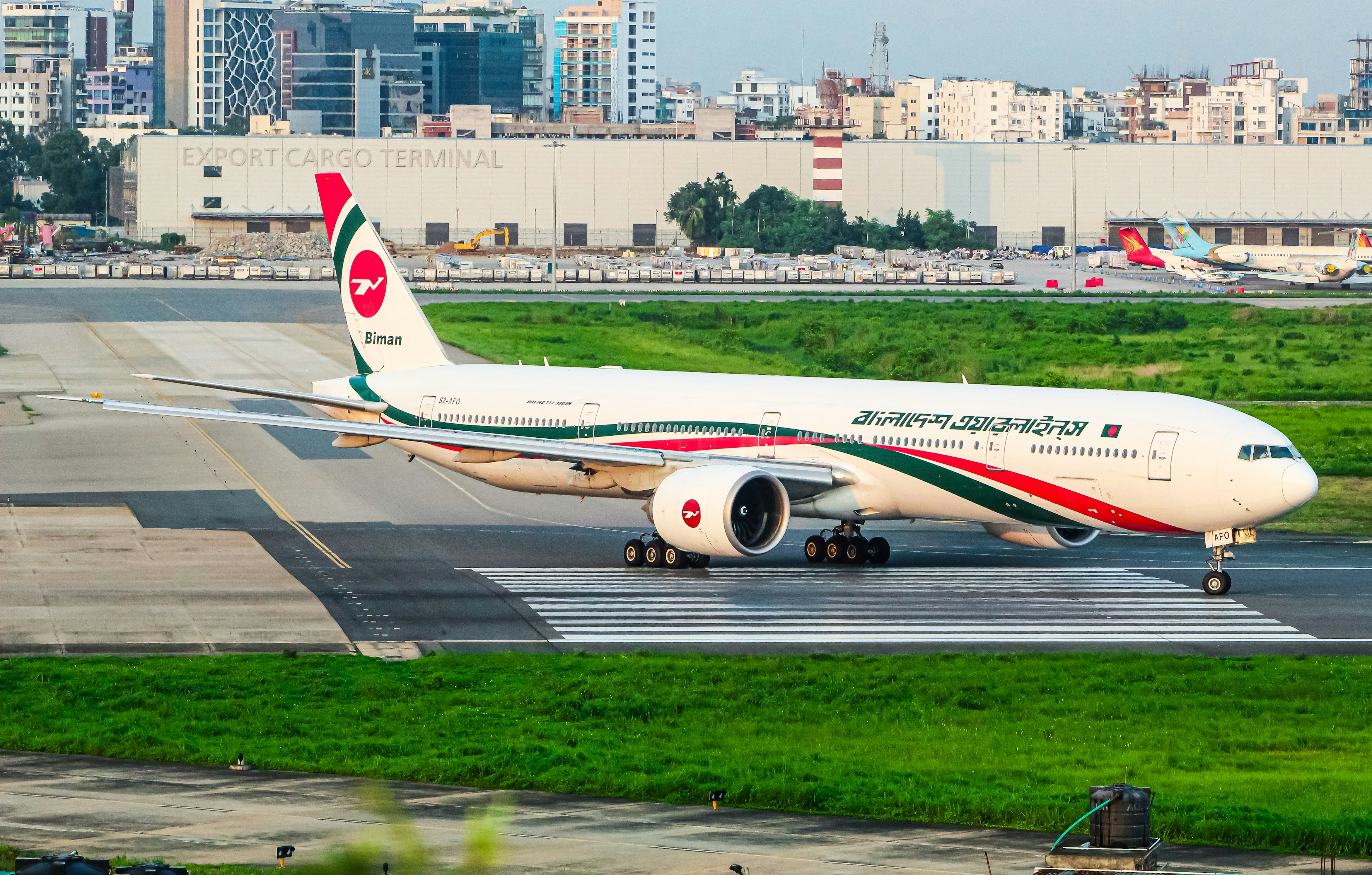 Taxiway Mirage: A Wide-Body Rolls Past City-Edge Terminals