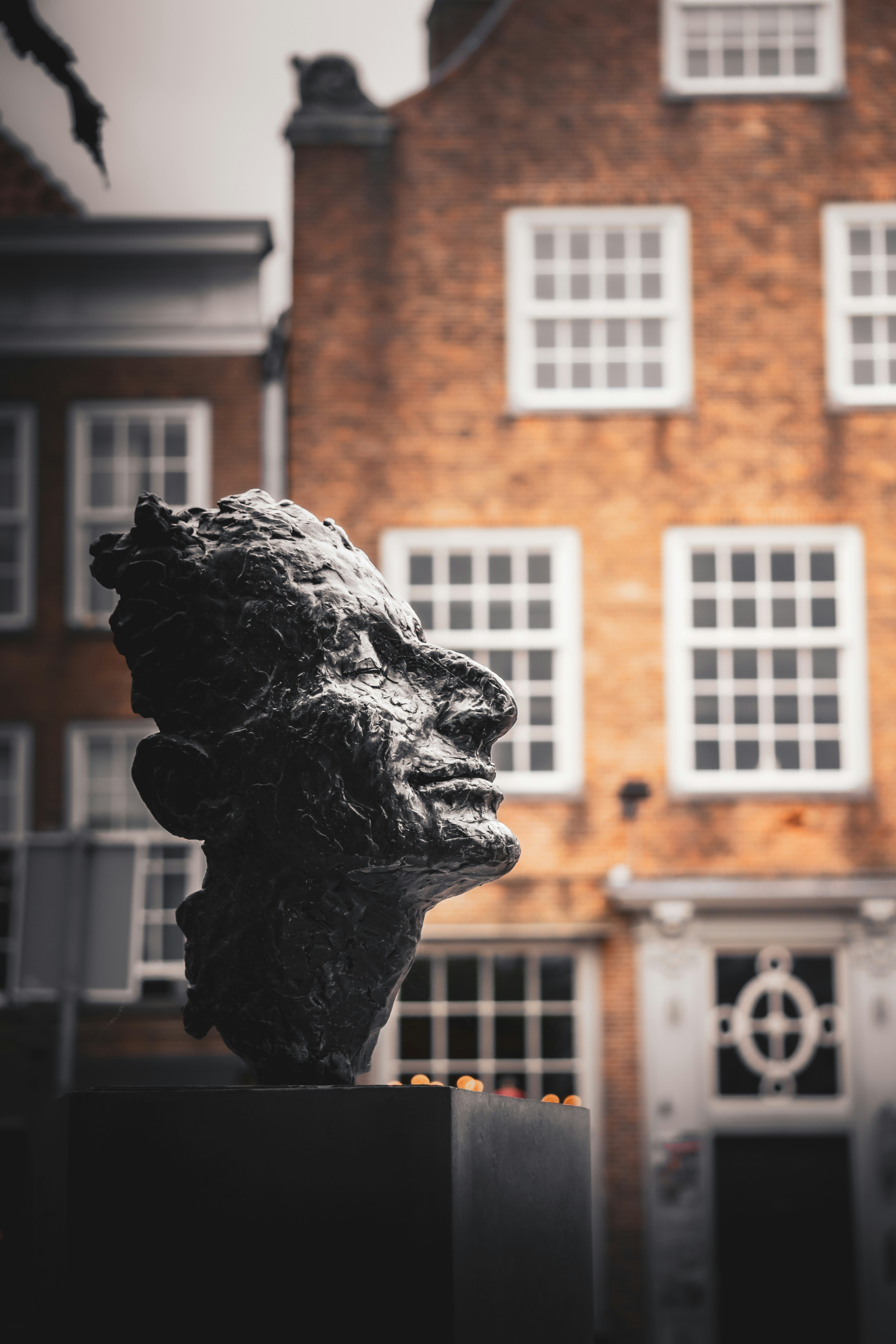 Bronze Breath: Portrait of a Quiet Guardian in an Urban Façade
