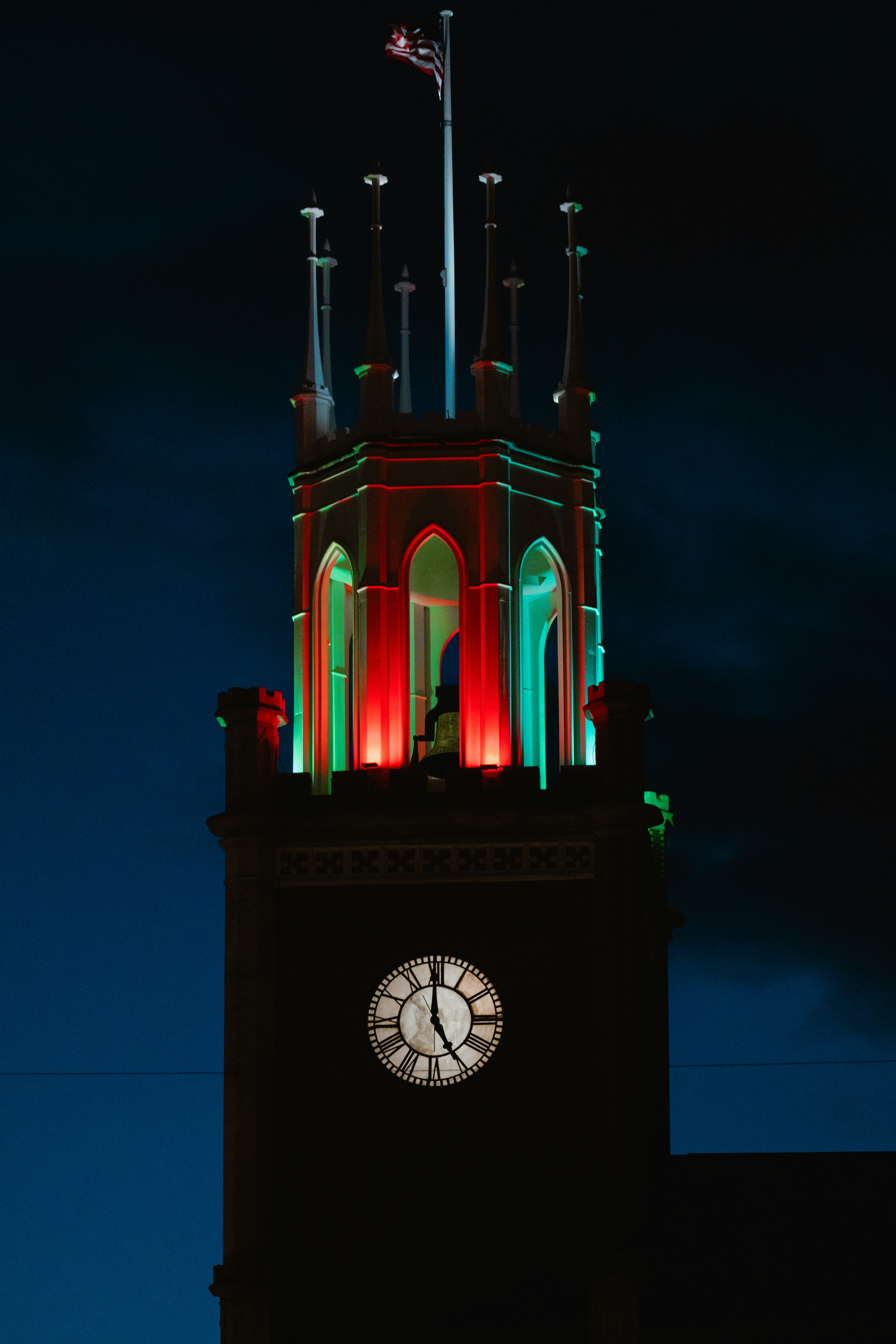 Chromatic Crown: Nighttime Clock Tower Bathed in Red and Green