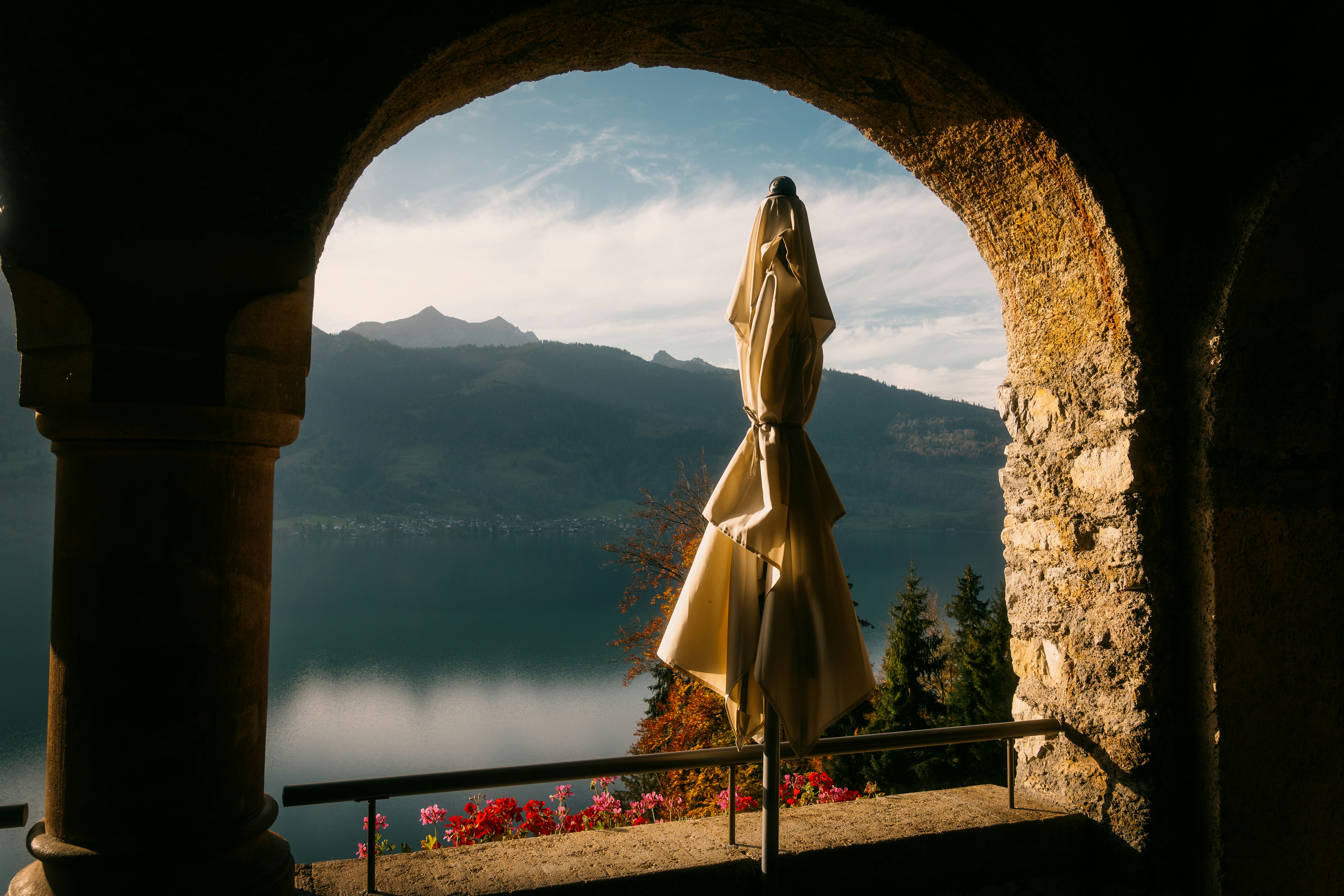 Stone Arch, Alpine Lake, and a Standalone Umbrella: Framing the Quiet