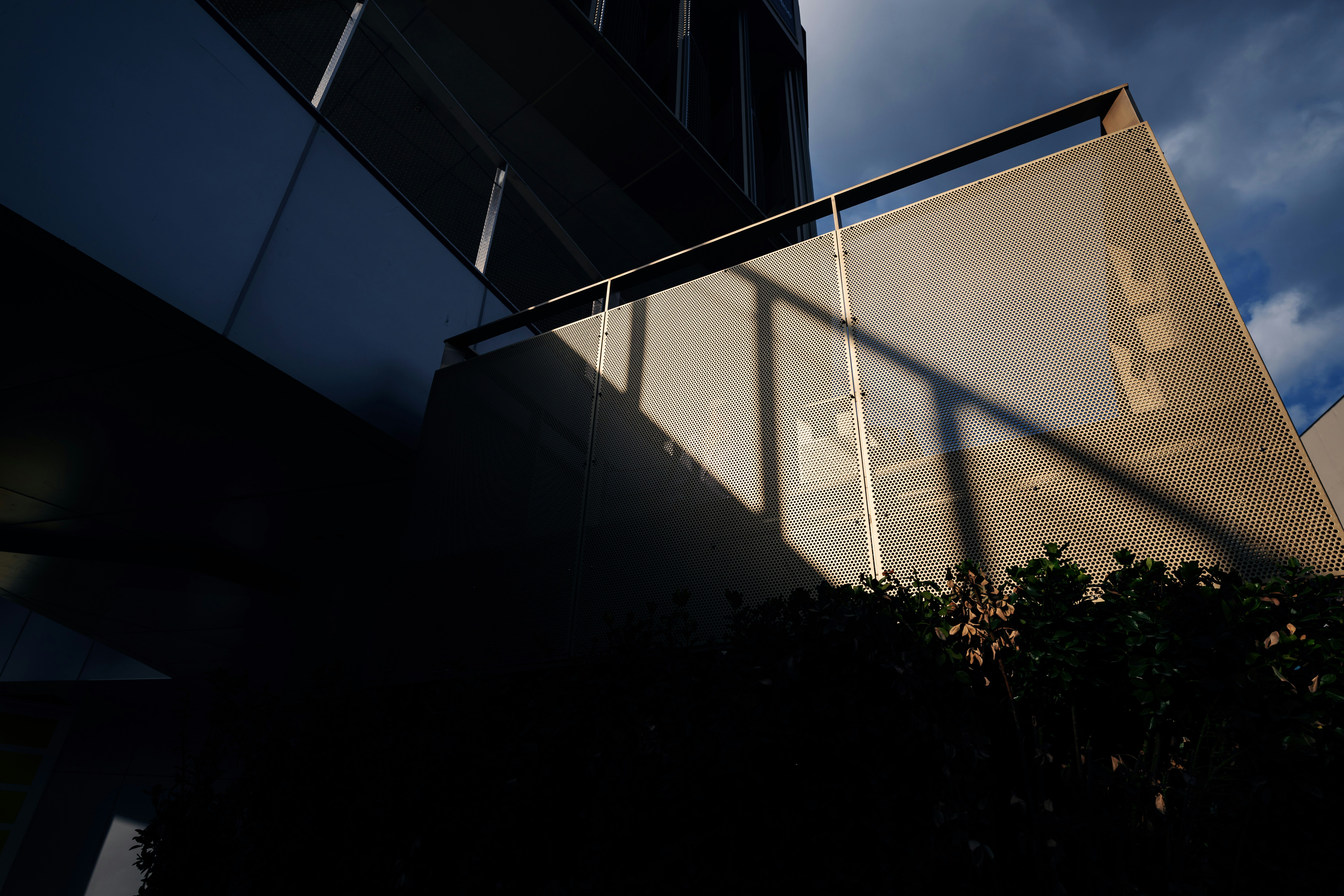 Sunlit Panel Over a Modern Facade: Geometry of Shadow