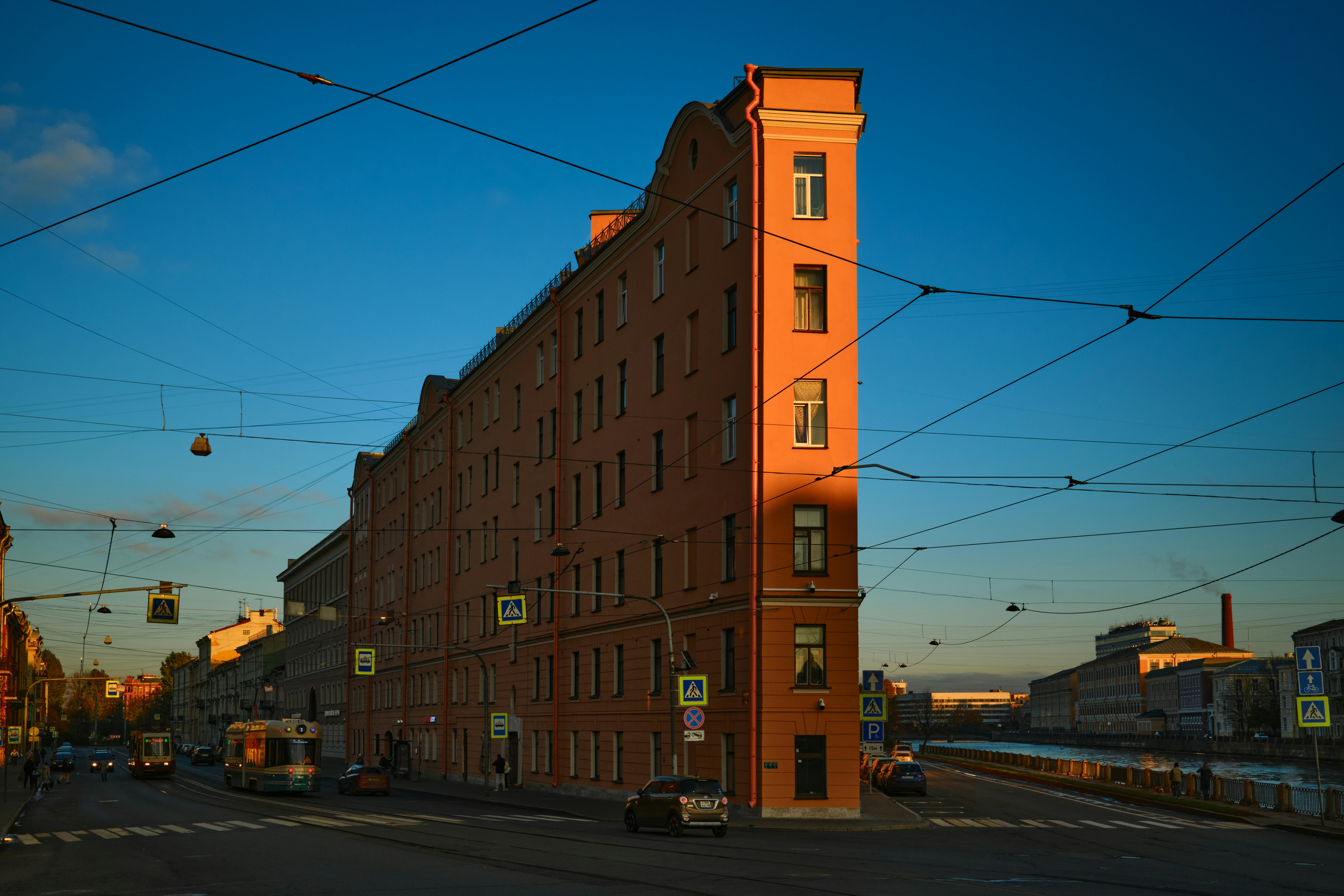 Sunlit Corner Tower Against a Loom of Tram Wires