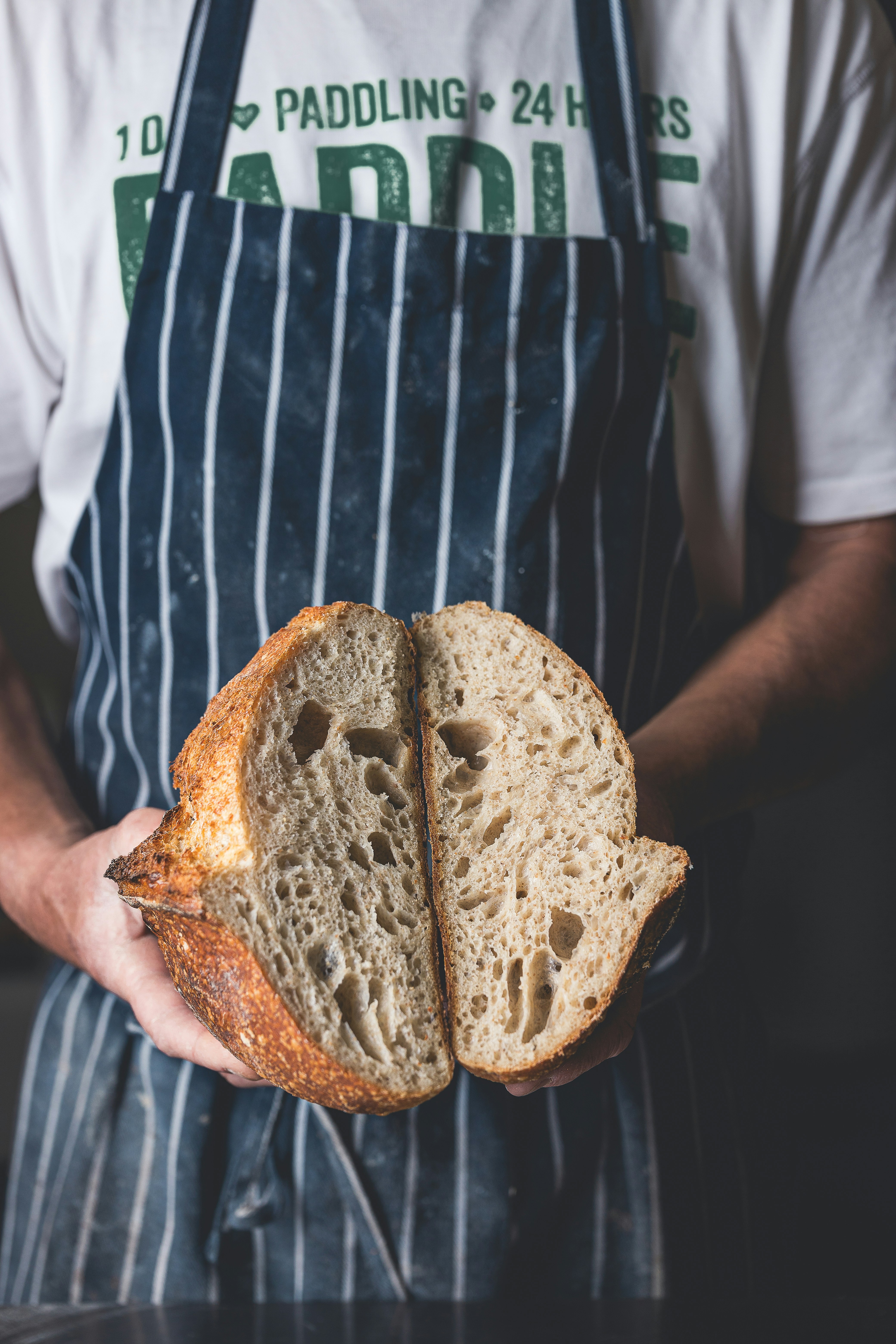 A man holding a loaf of bread in his hands photo – Free New zealand ...